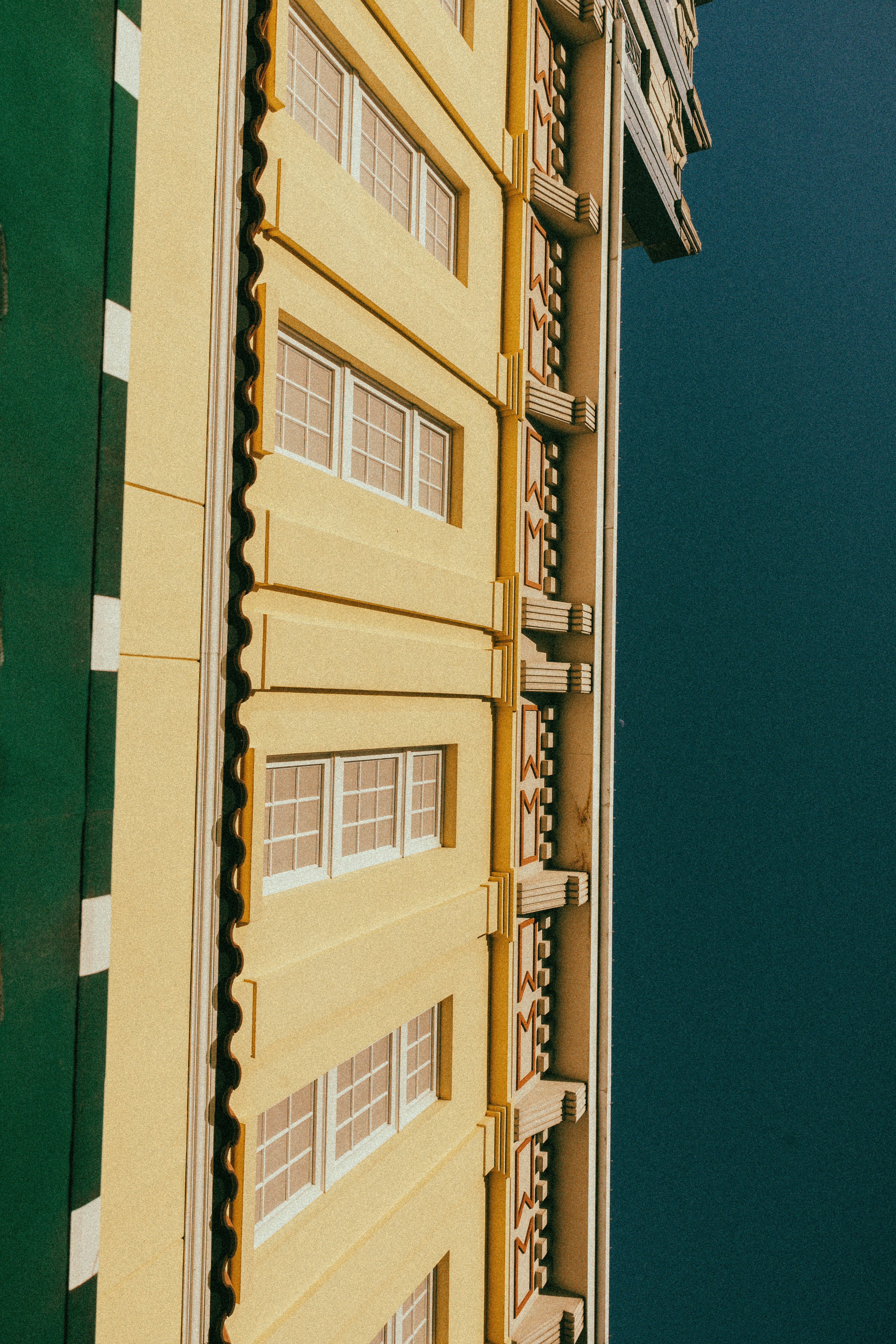 Tall yellow building with many windows next to water photo – Free Usa ...