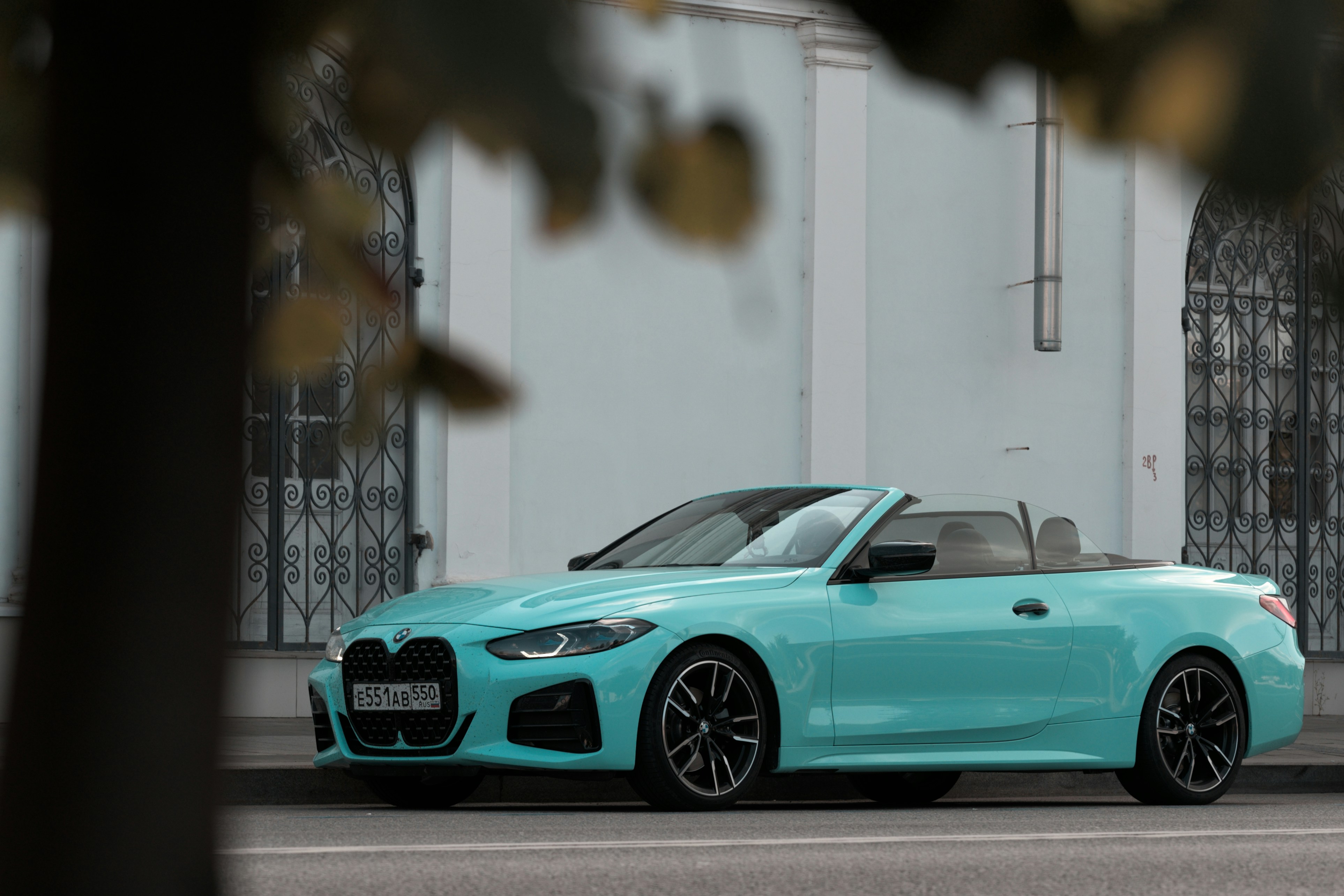 A turquoise convertible car parked on a street. photo – Free Wallpaper ...