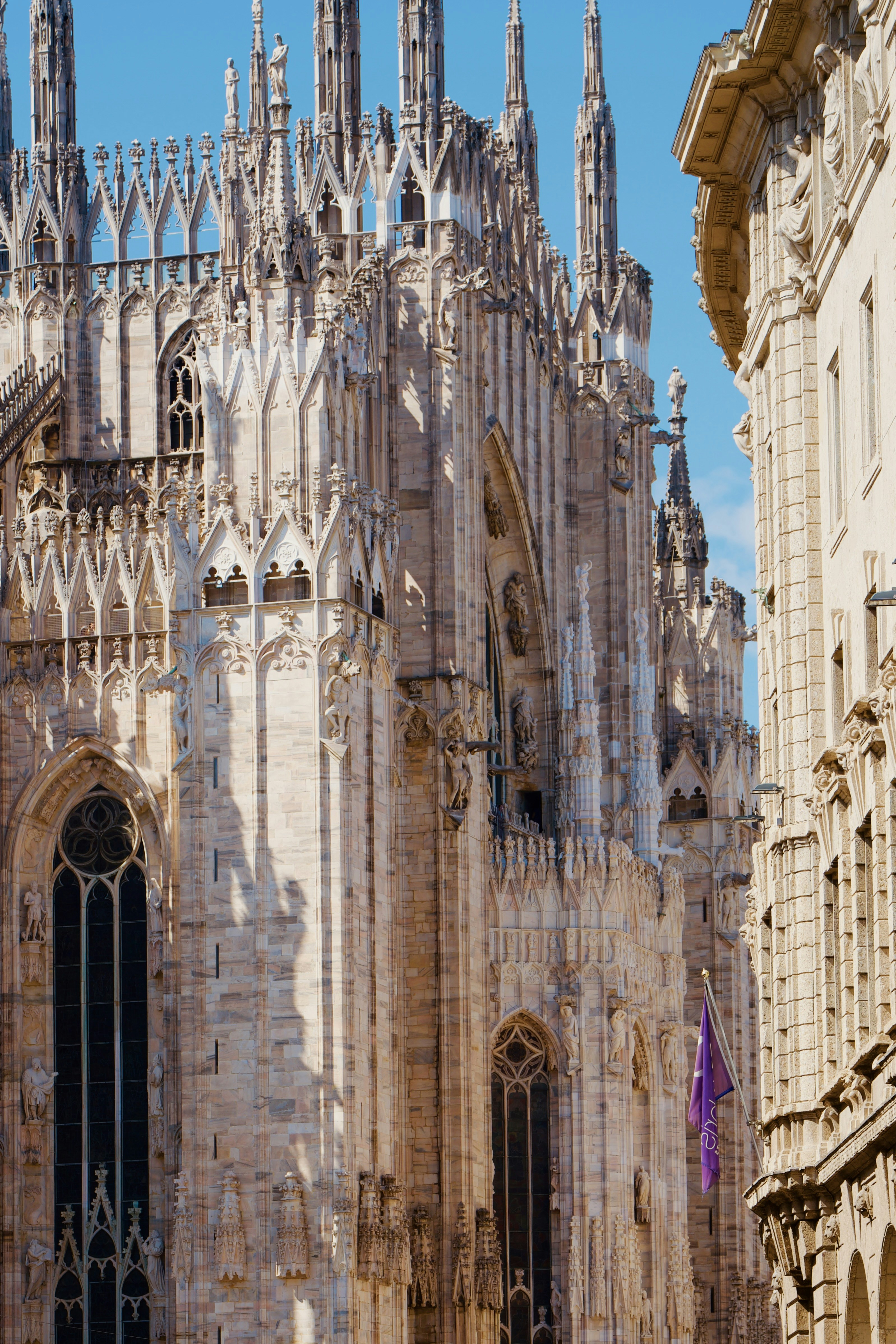 Ornate gothic cathedral with intricate spires against blue sky.