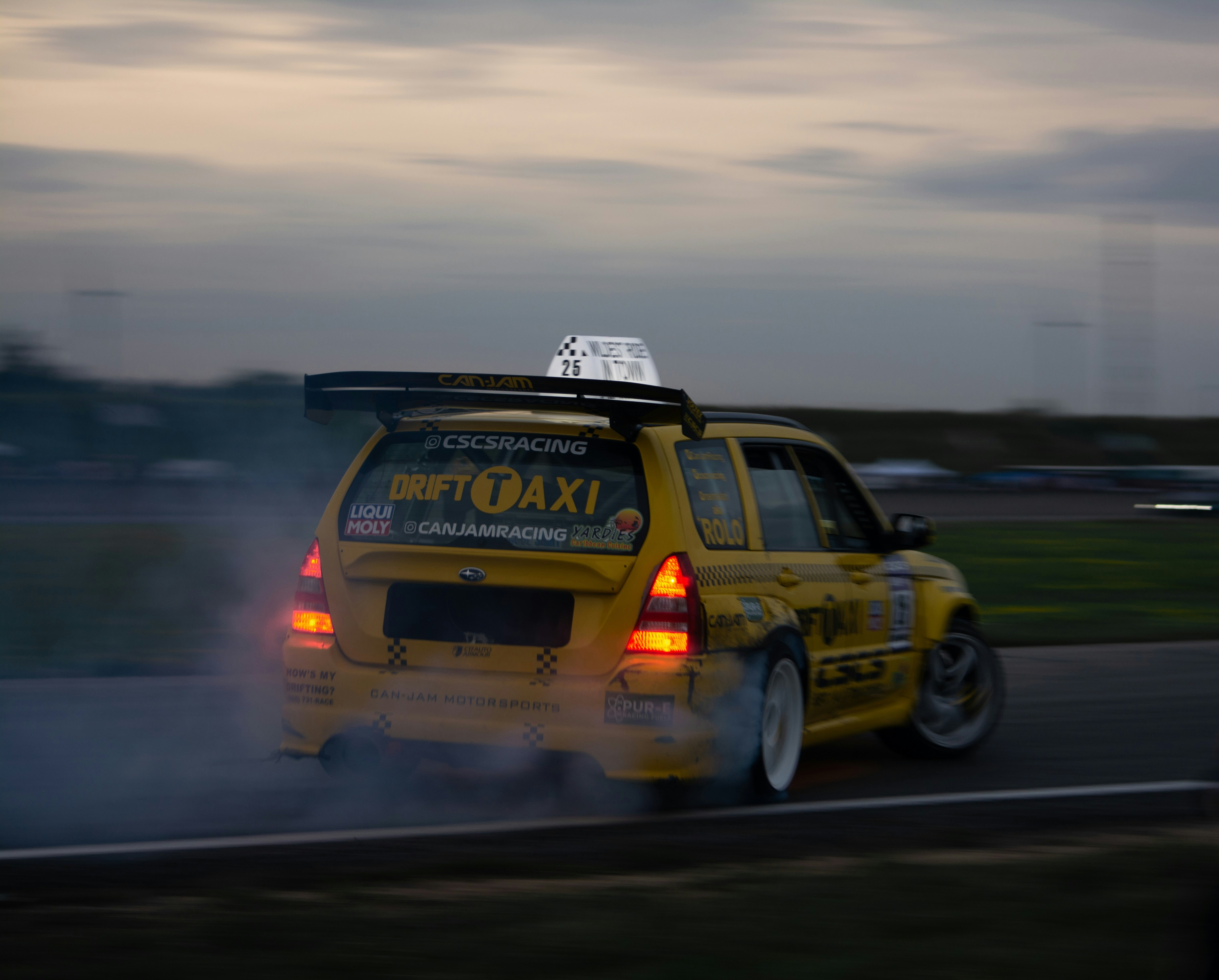 Yellow car drifting on a race track