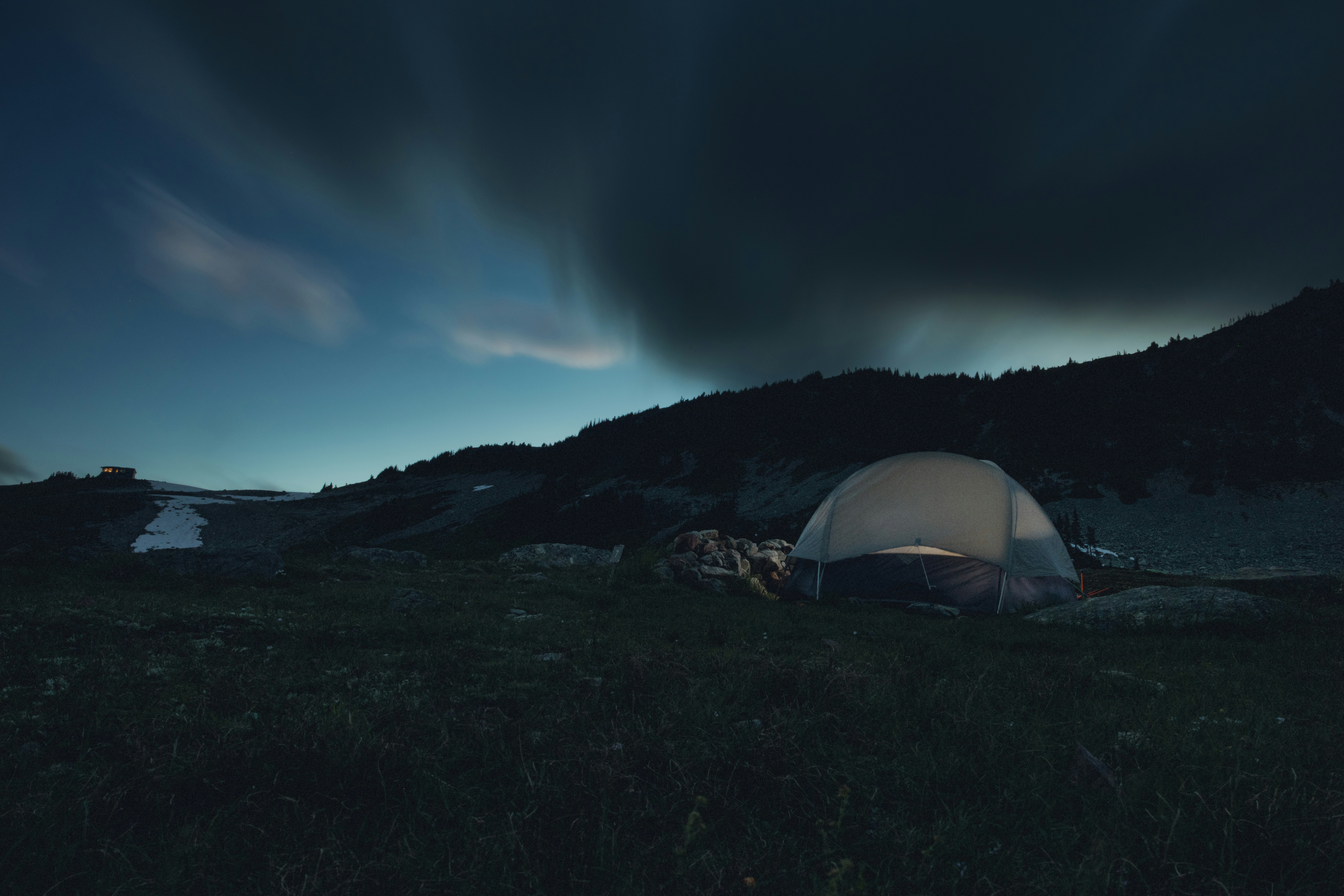 Tent glowing under the aurora borealis at night