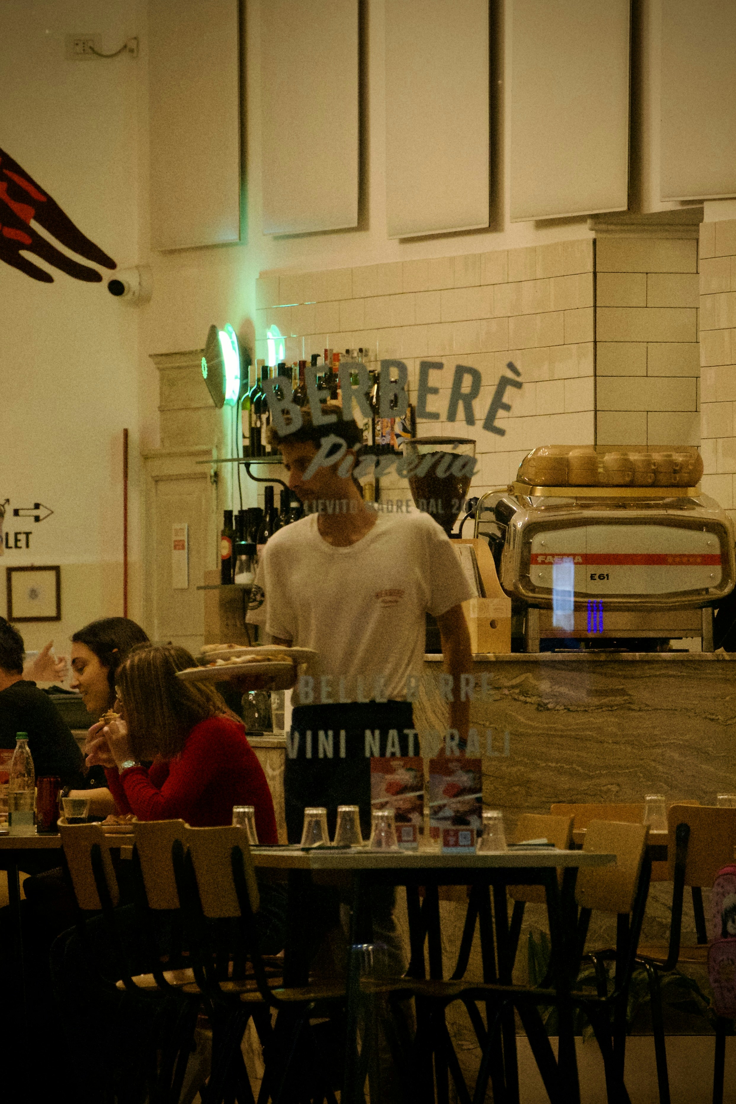 Waiter serving customers in a busy restaurant