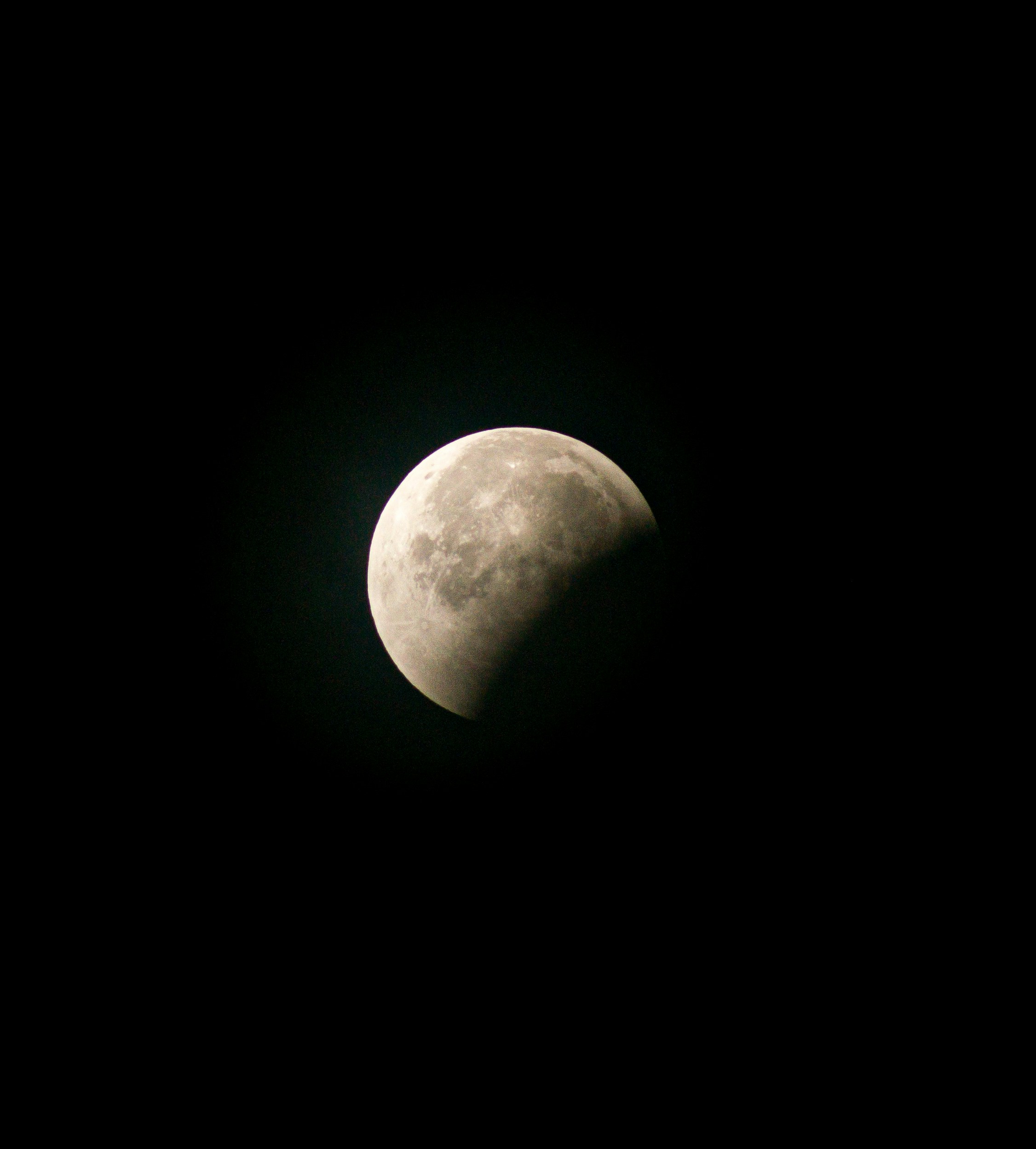 Lunar eclipse. | A partial lunar eclipse against a black sky.