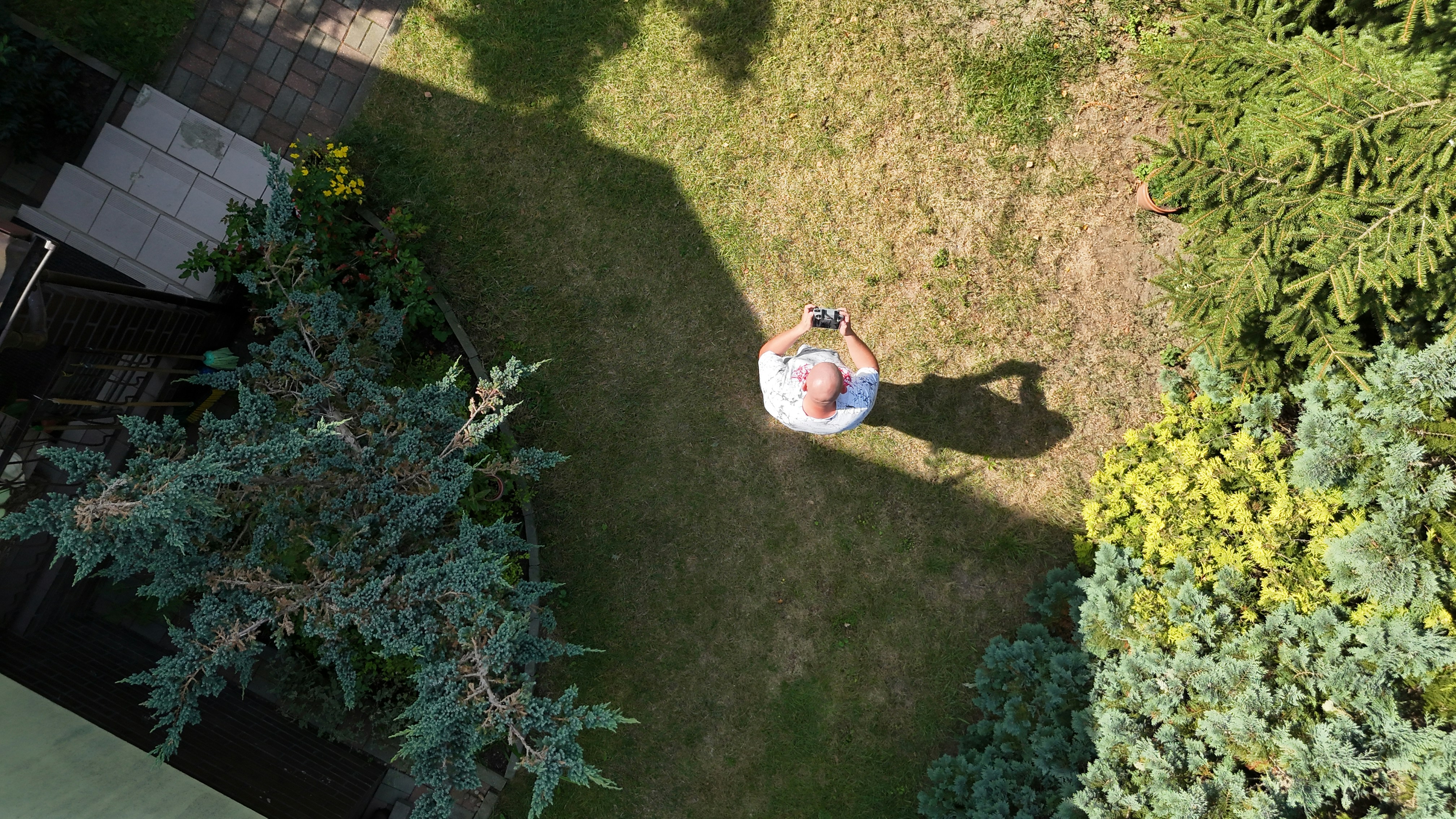 Zdjęcia z Dronów flyxpress.pl, Robimy zdjęcia dronami z Warszawy i Pod Warszawą. | Person with a bucket in a grassy backyard