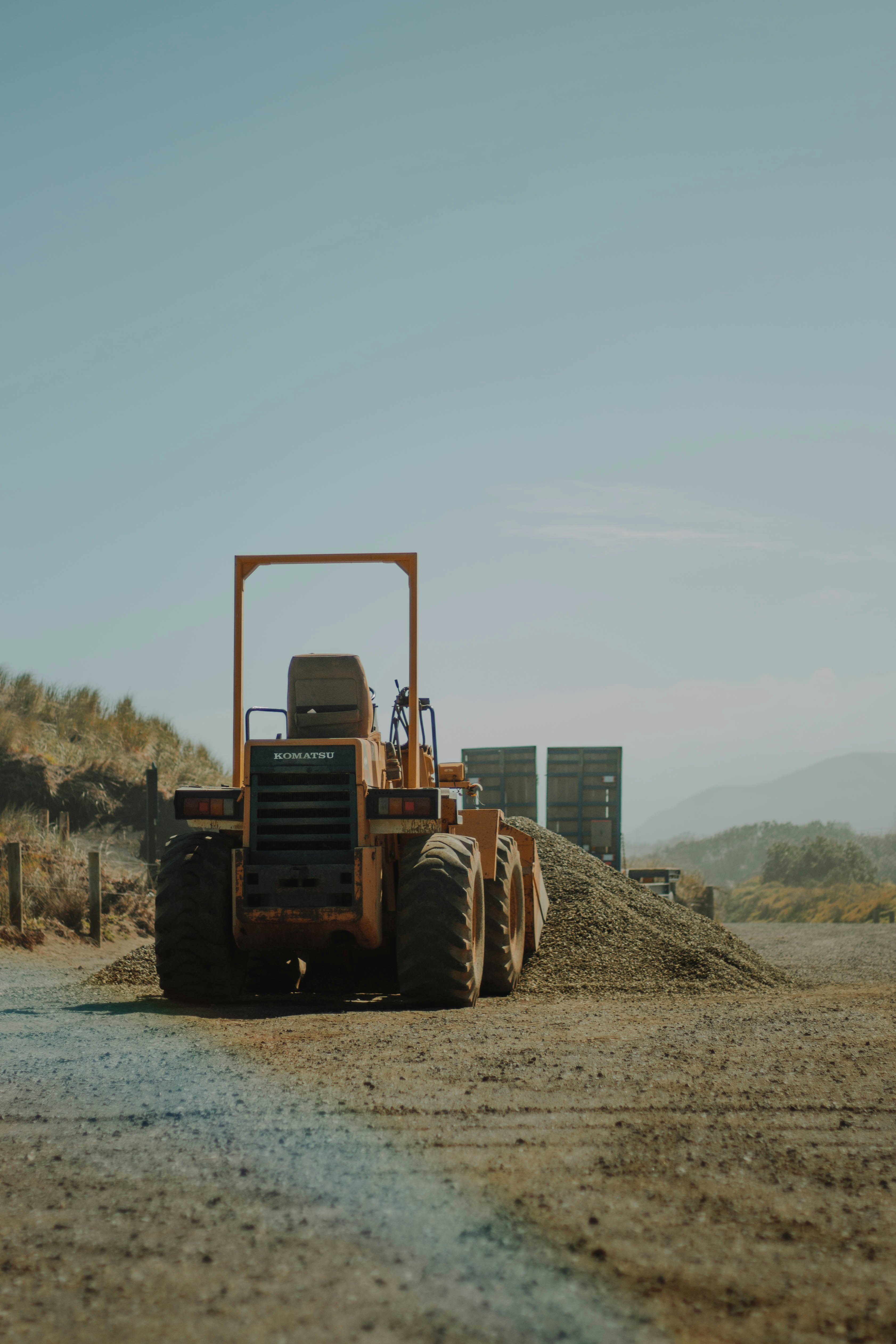 Gravel Road Guardian: A Bulldozer Anchored in Dust