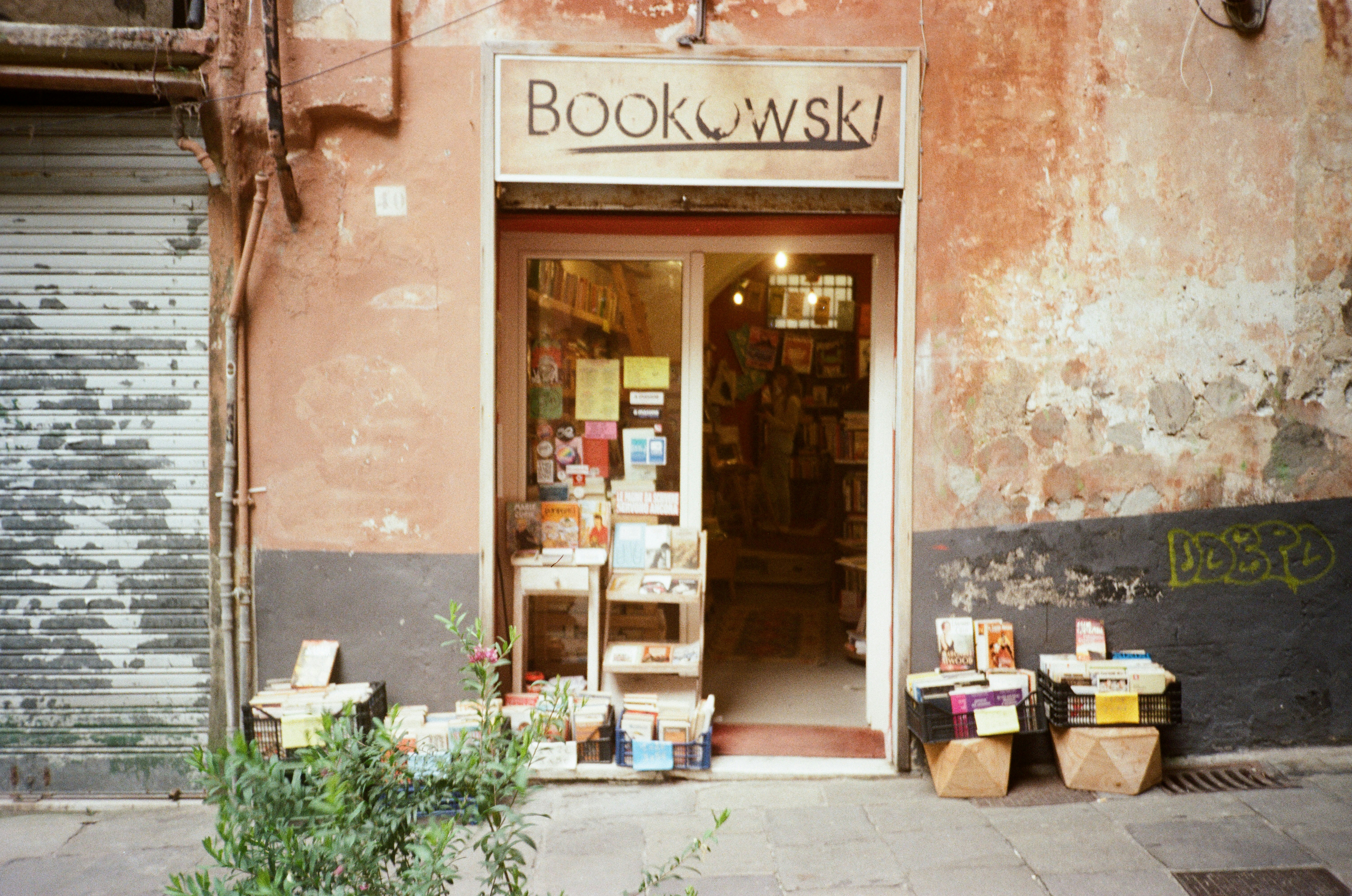 Entrance of a quaint bookstore with books displayed outside.