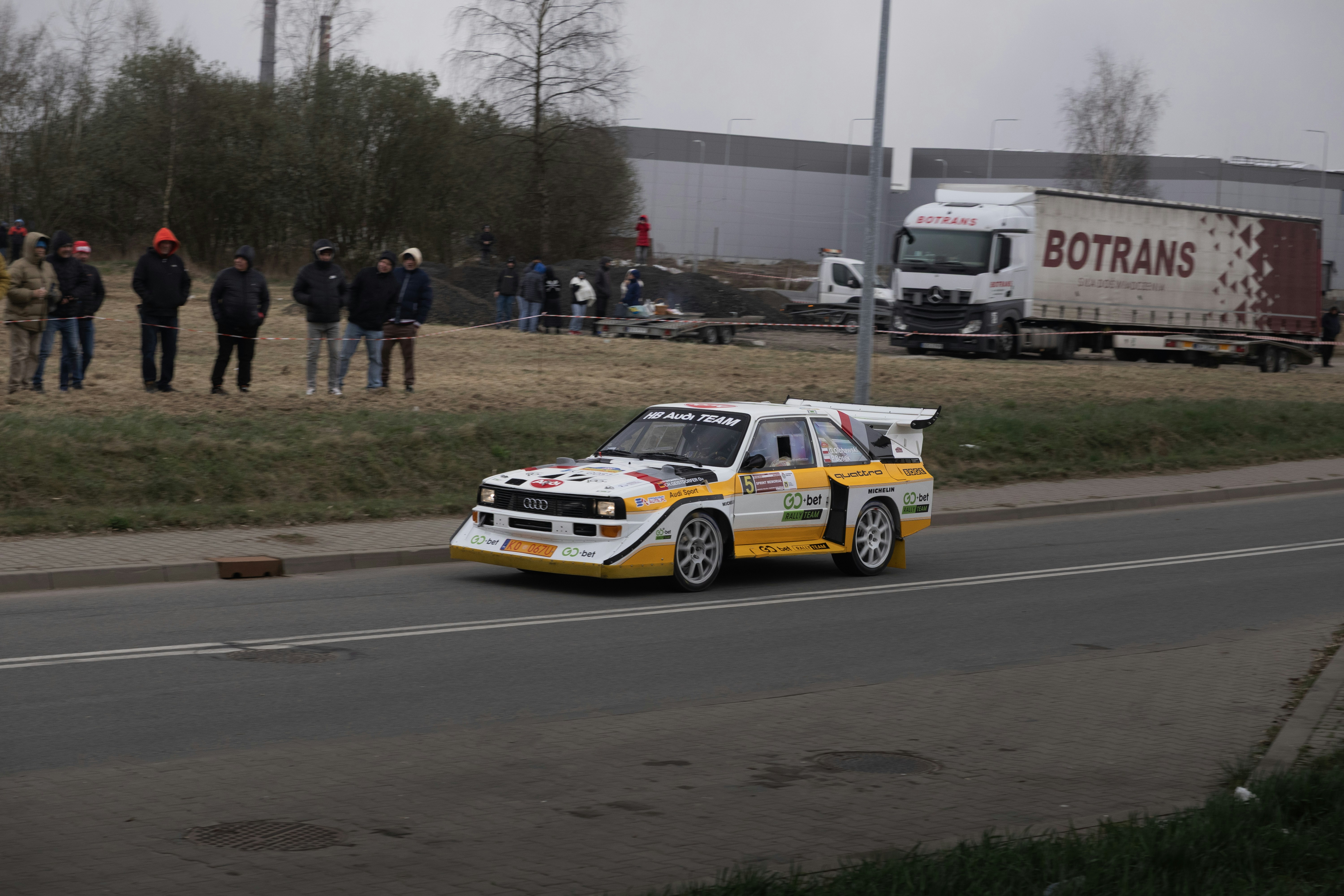A rally car drives on a road with spectators. photo – Free Race Image ...