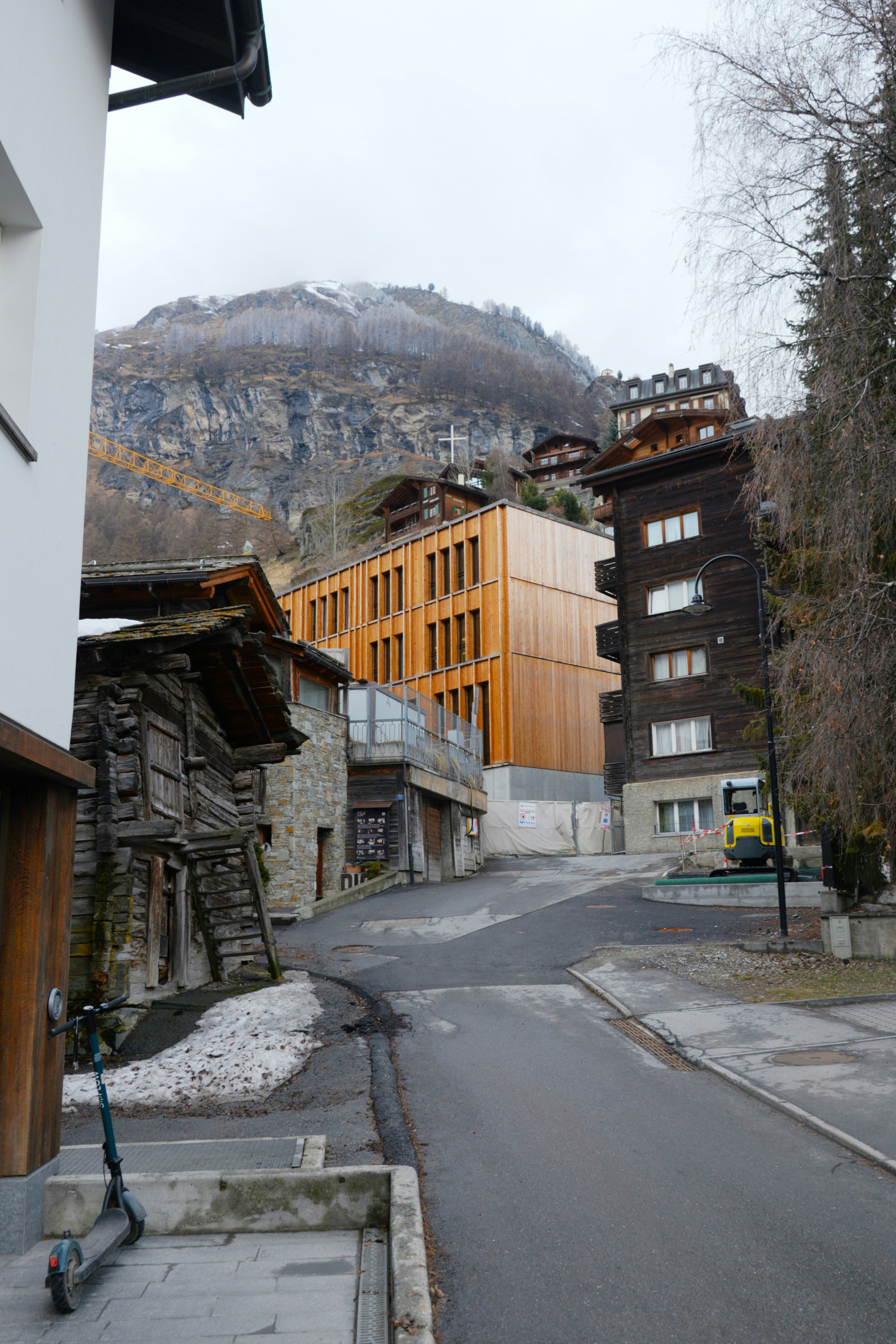 Concrete and Timber on a Mountain Street: A New Facade Among Old Chalets