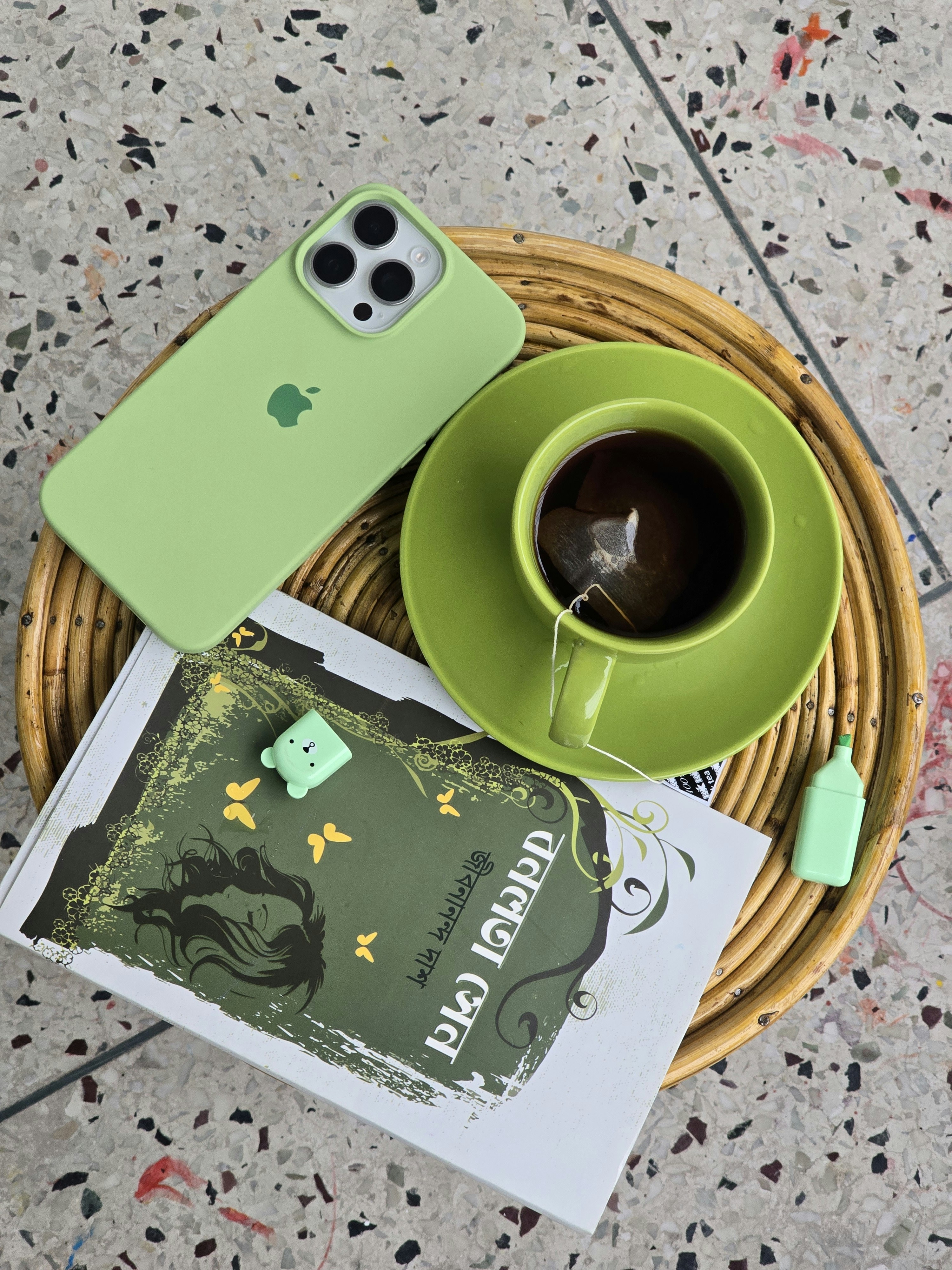 Minty Morning Ritual: Coffee, Book, and Tech on a Wicker Tray