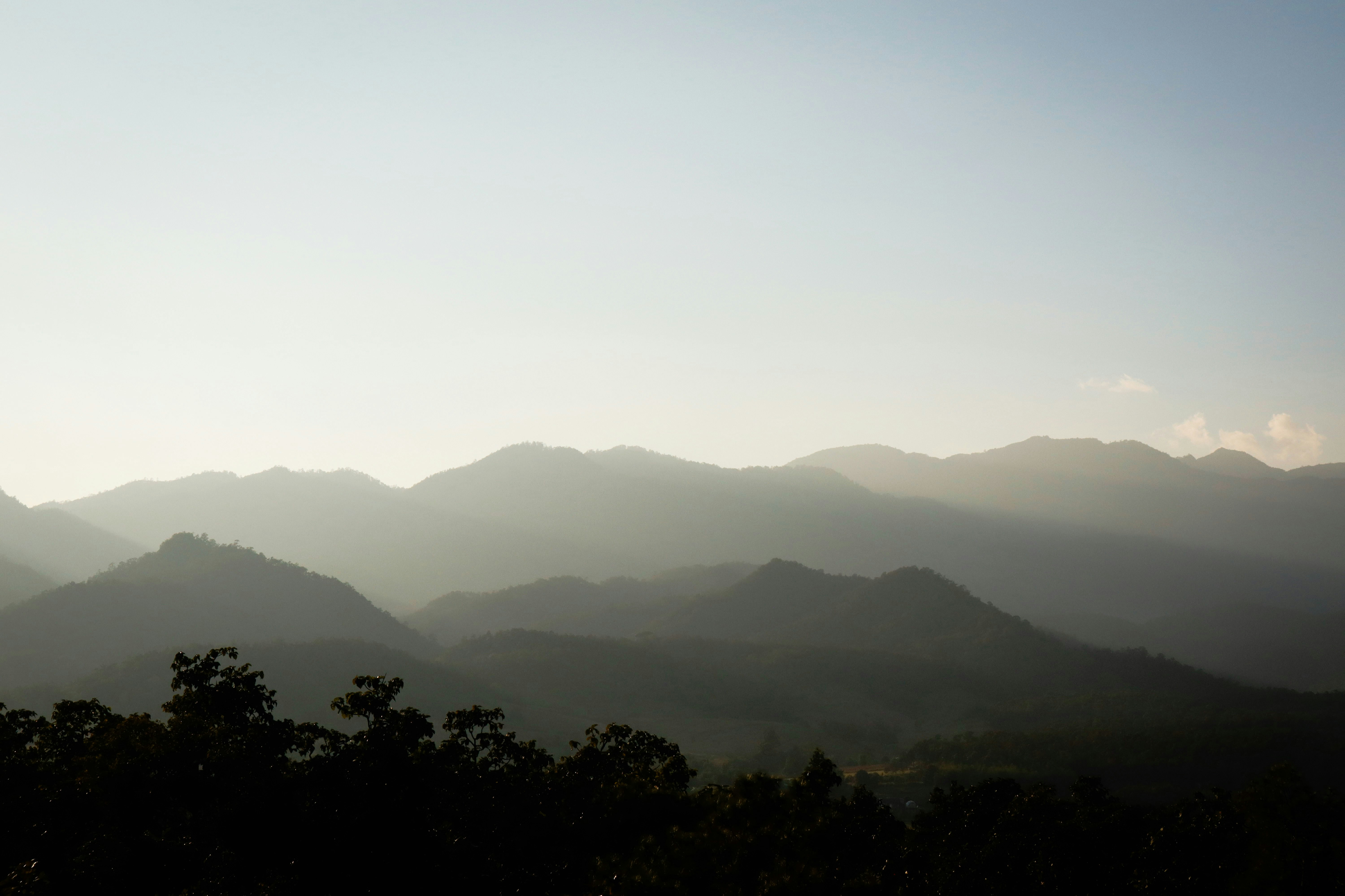 Silhouetted mountain ranges fading into the sky