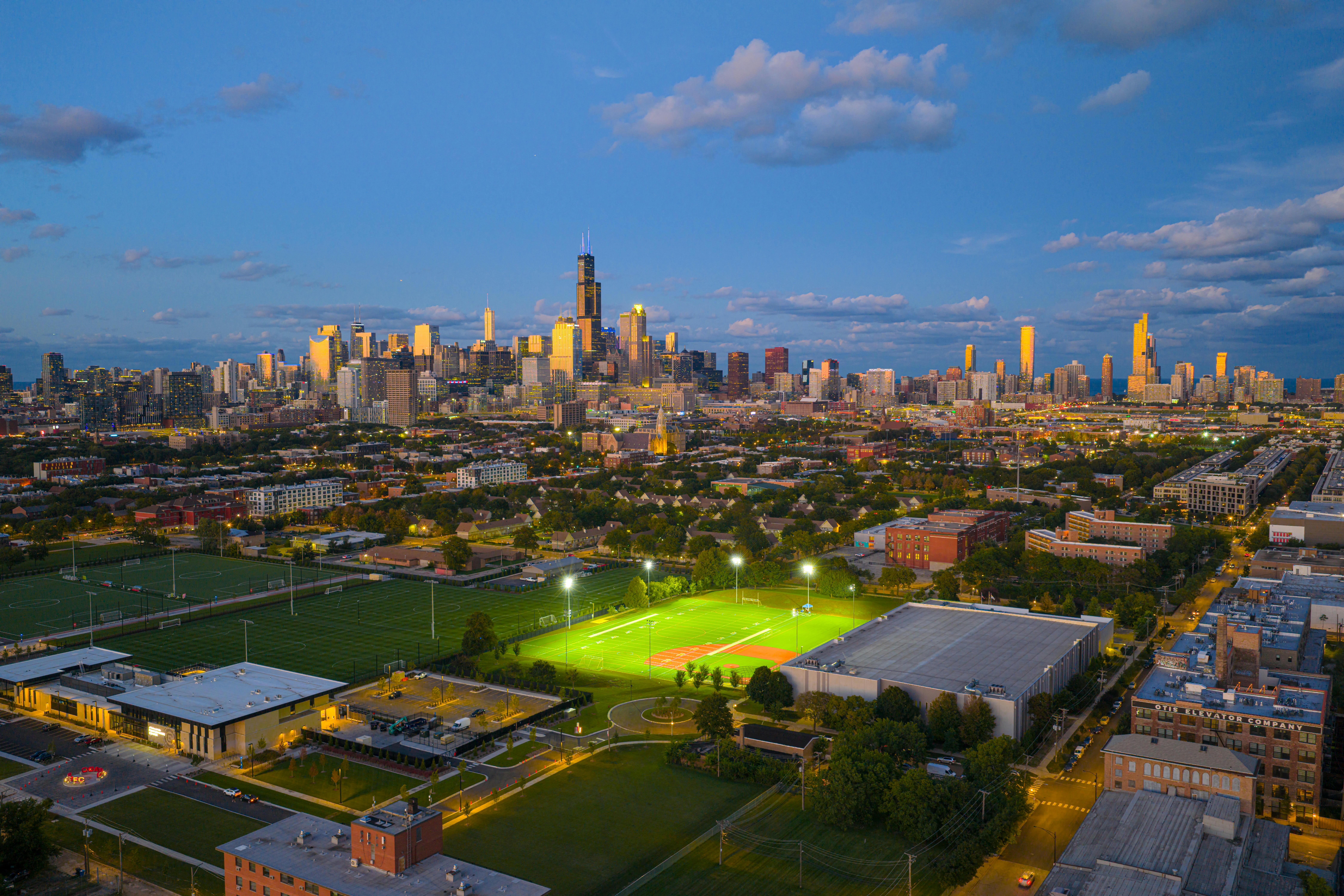 City skyline at dusk with illuminated baseball fields. photo – Free ...