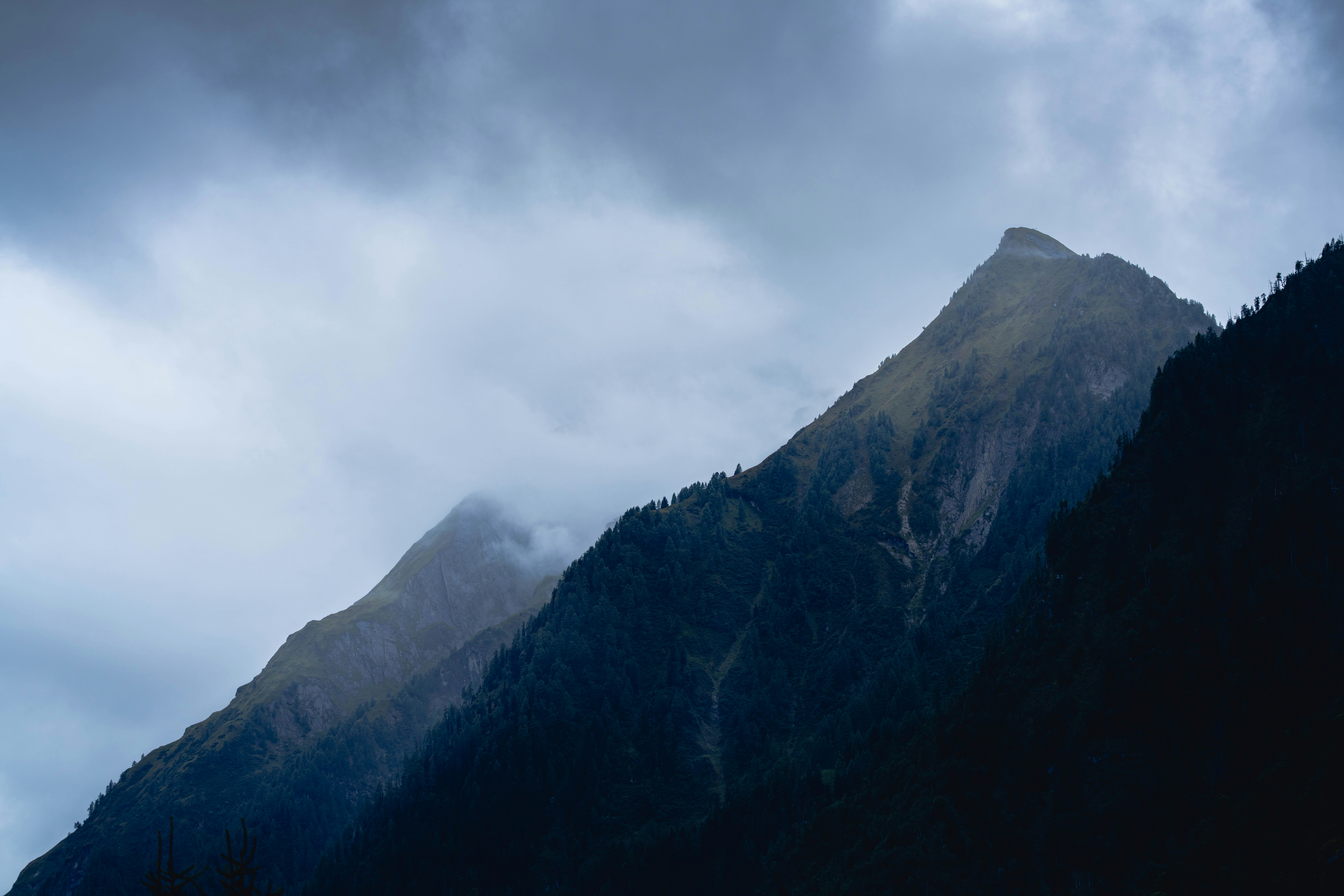 Dark, misty mountains under a cloudy sky.