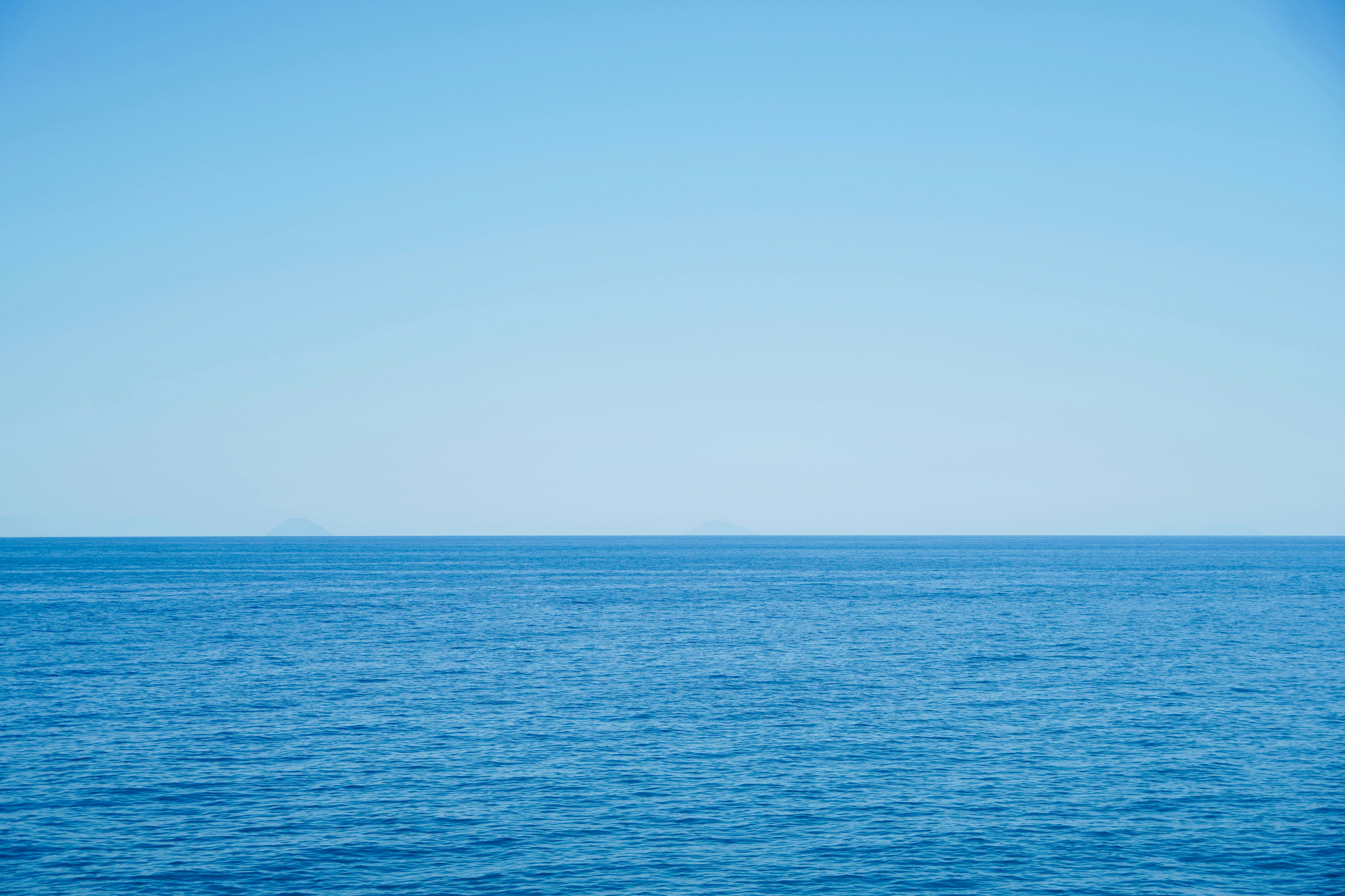 Calm blue ocean stretching to the horizon under clear sky
