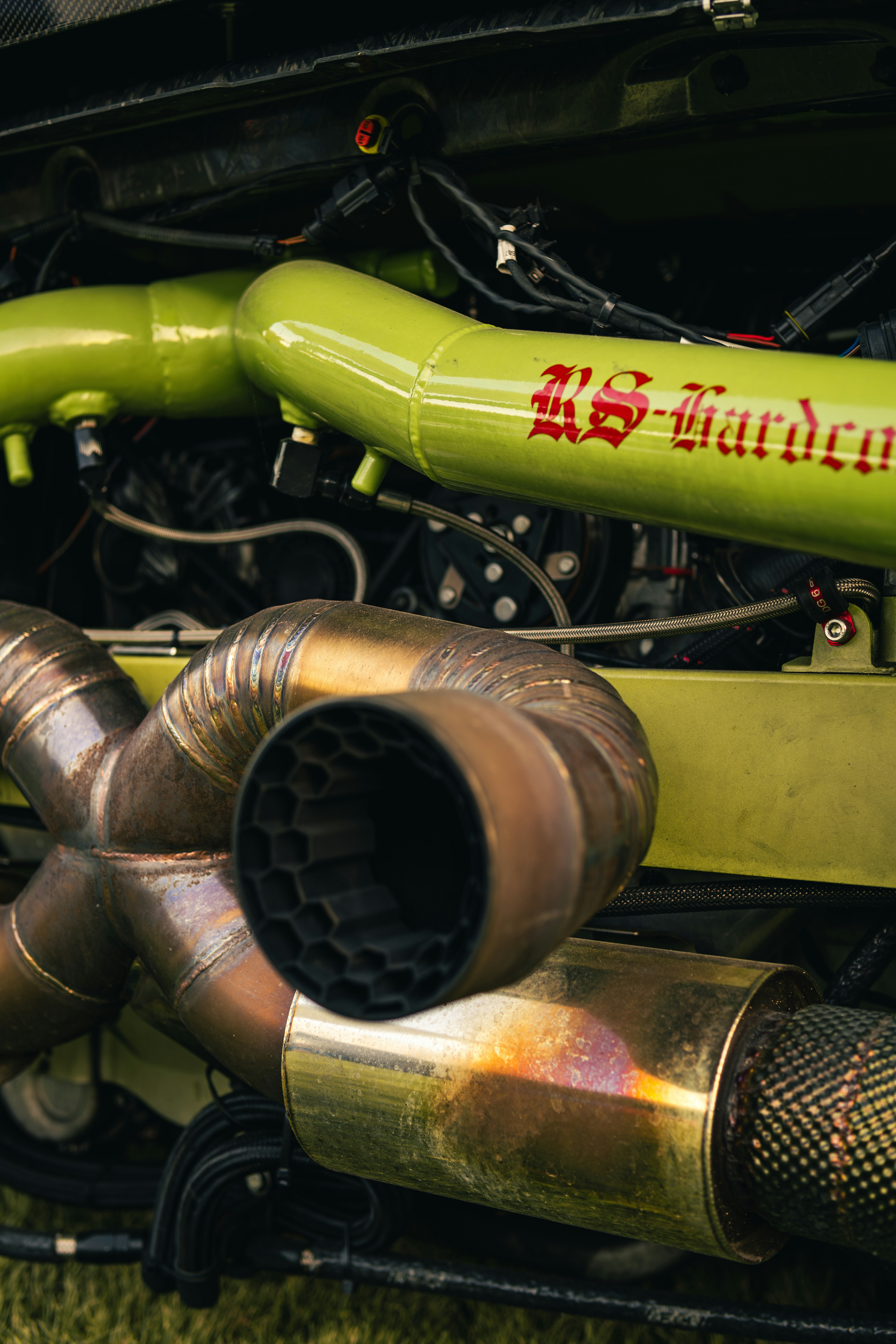 Lime-Green Engine Heartbeat: Close-Up on a Honeycomb Exhaust