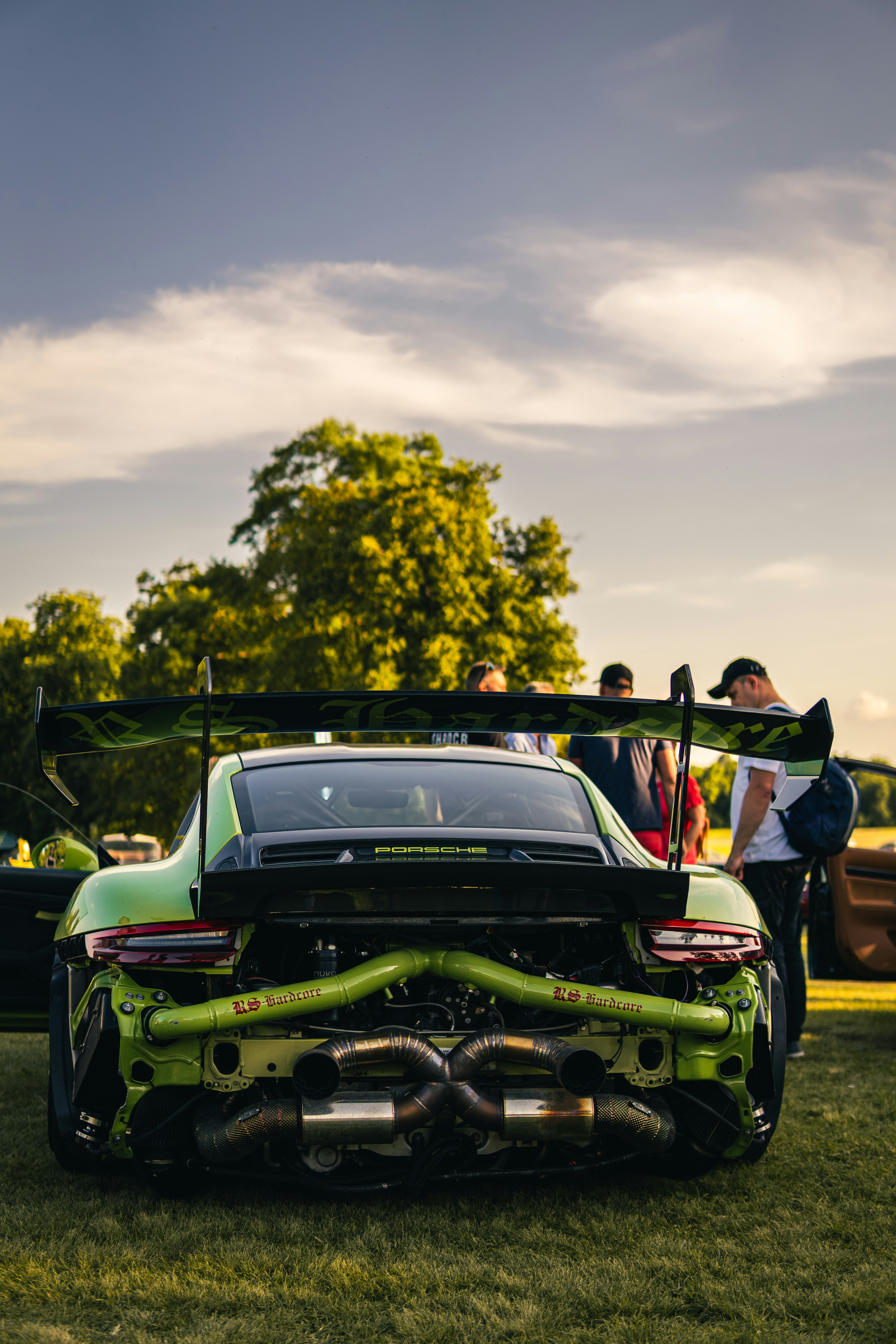 Porsche 911 GT3 RS Hardcore | Green racing car with large spoiler and exhaust pipes.