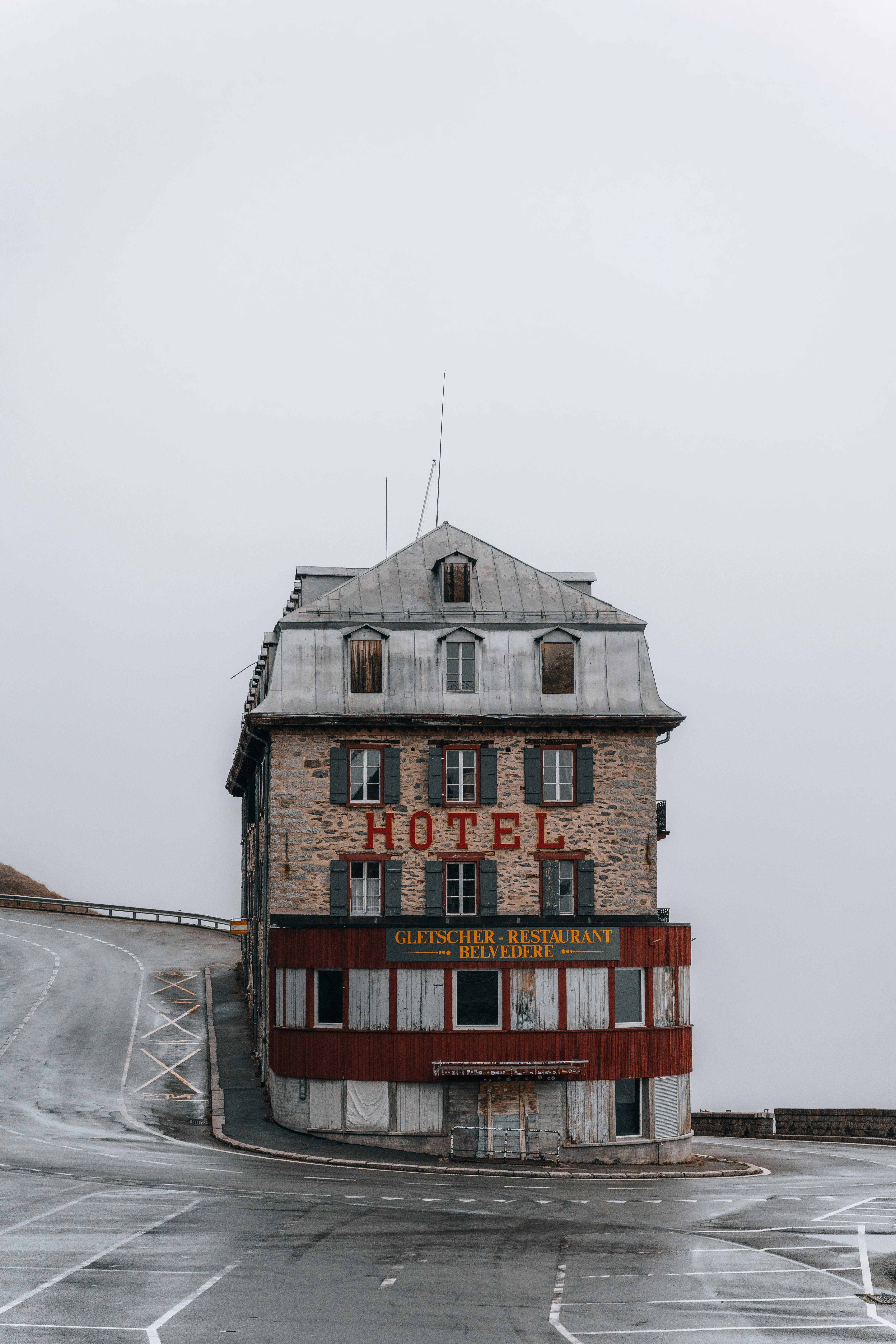 Old hotel building on a foggy mountain road
