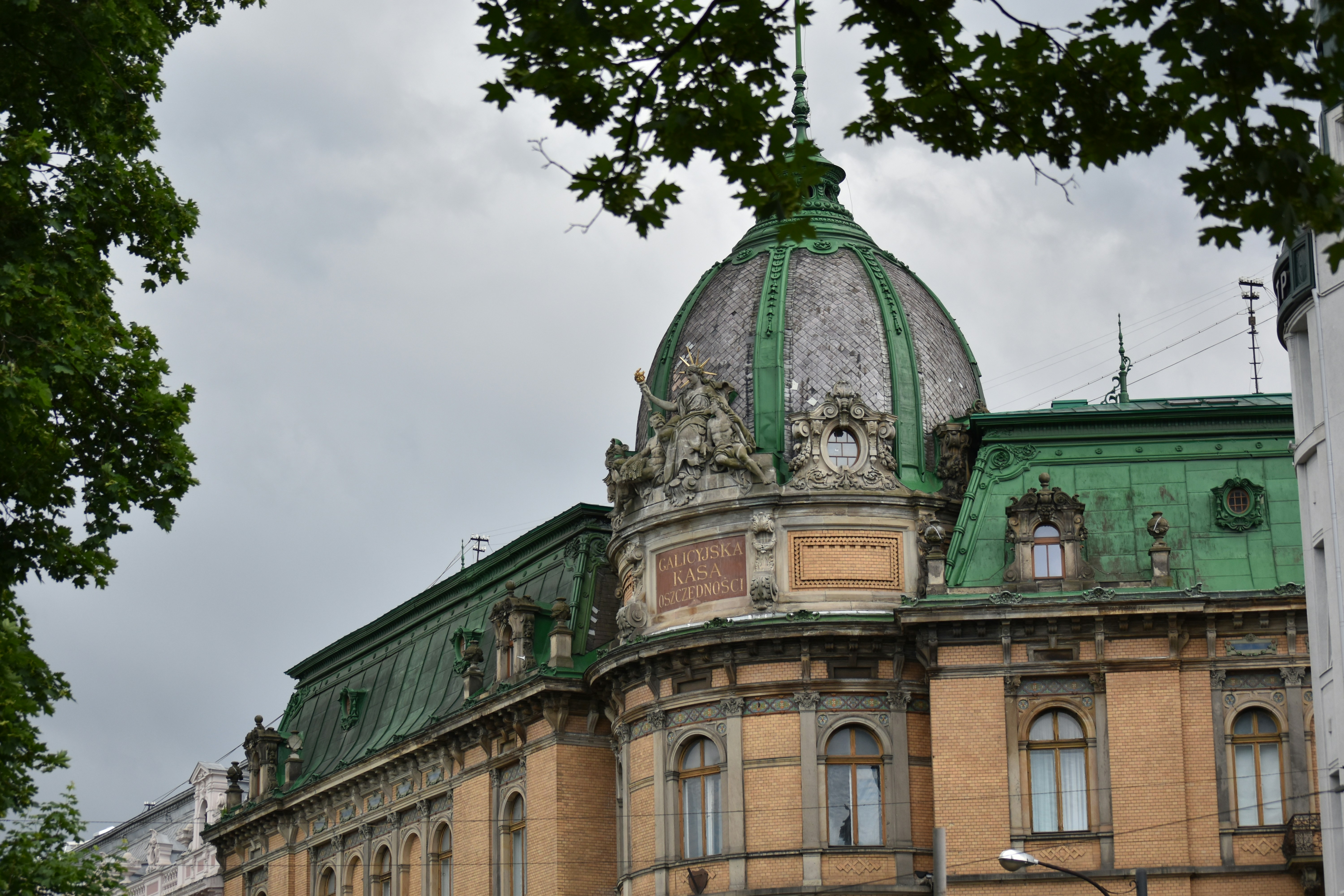 Ornate historic building with green mansard roof and dome.