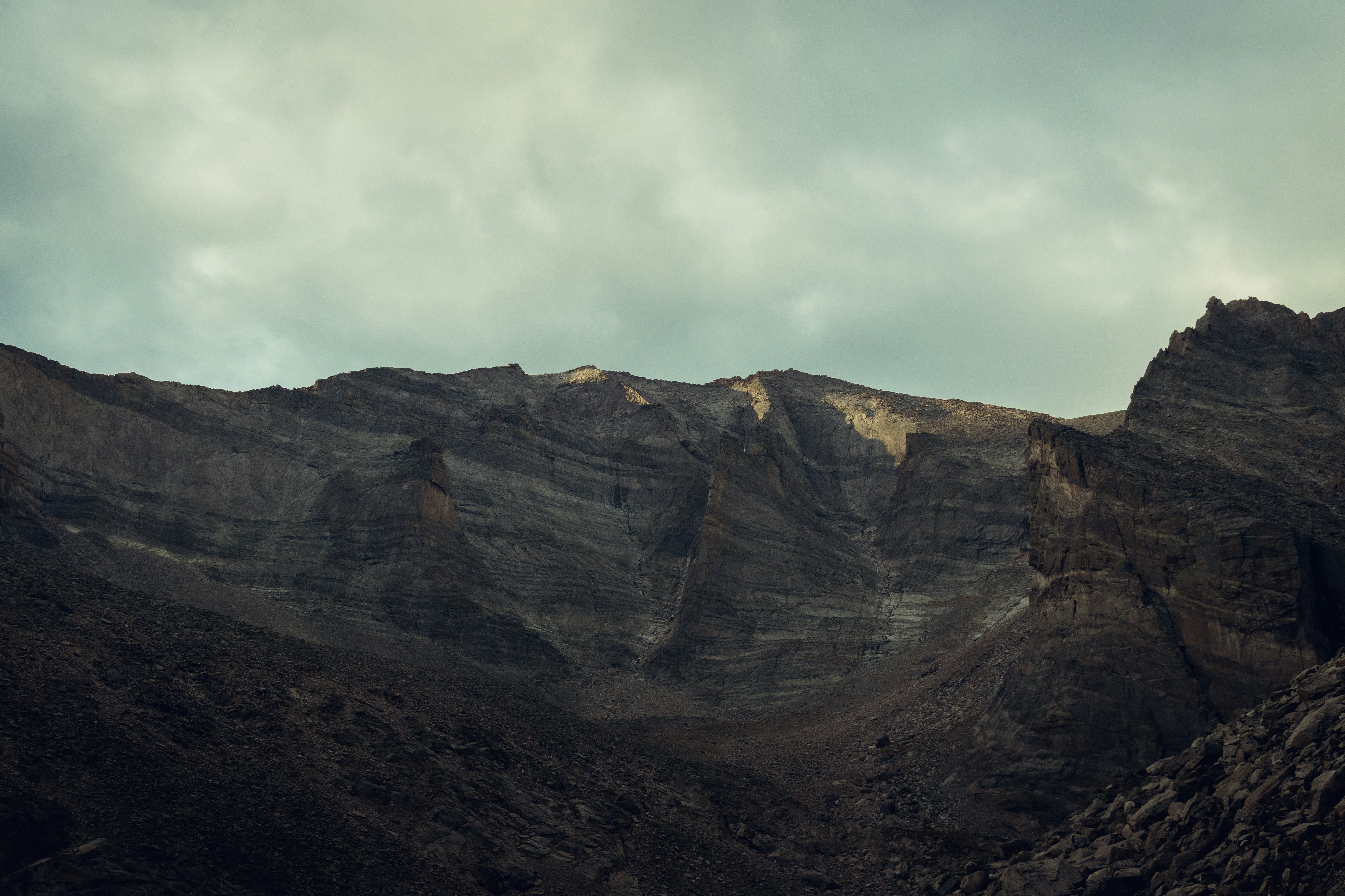 Rugged mountain range under cloudy sky