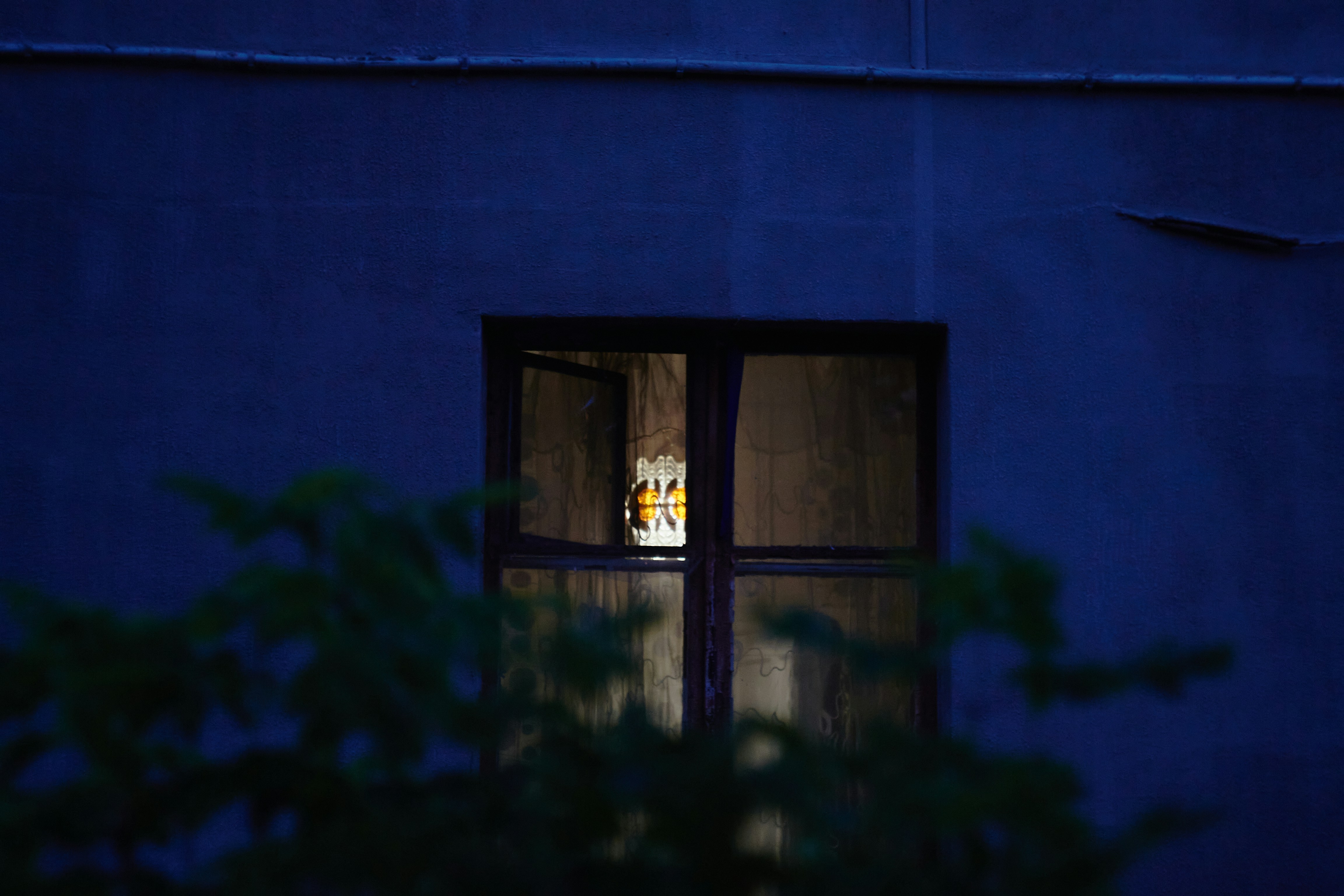 A dimly lit window with a bright light inside.