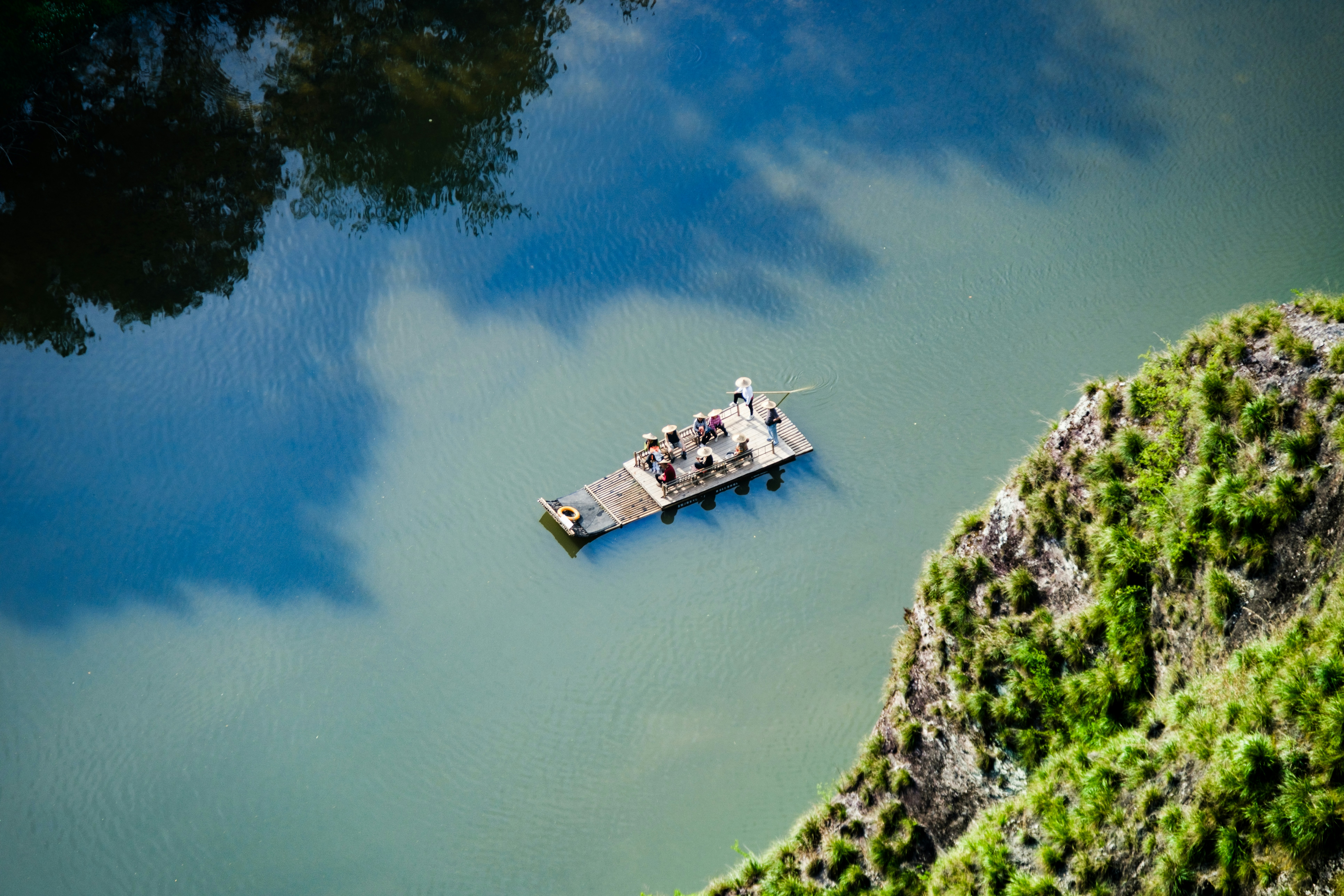 People on a raft in a calm lake