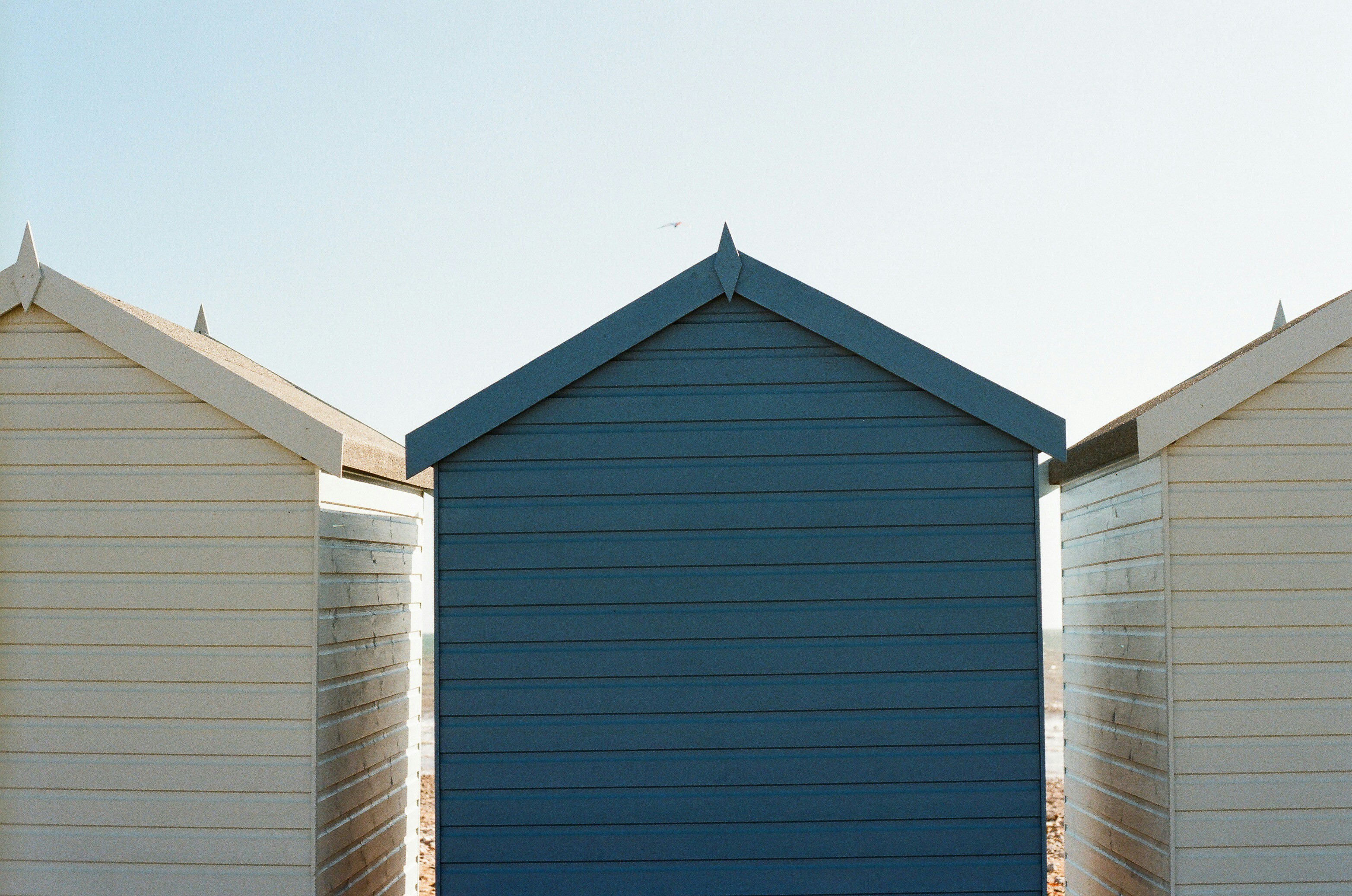 Three beach huts with a blue one in the middle. photo – Free Film ...