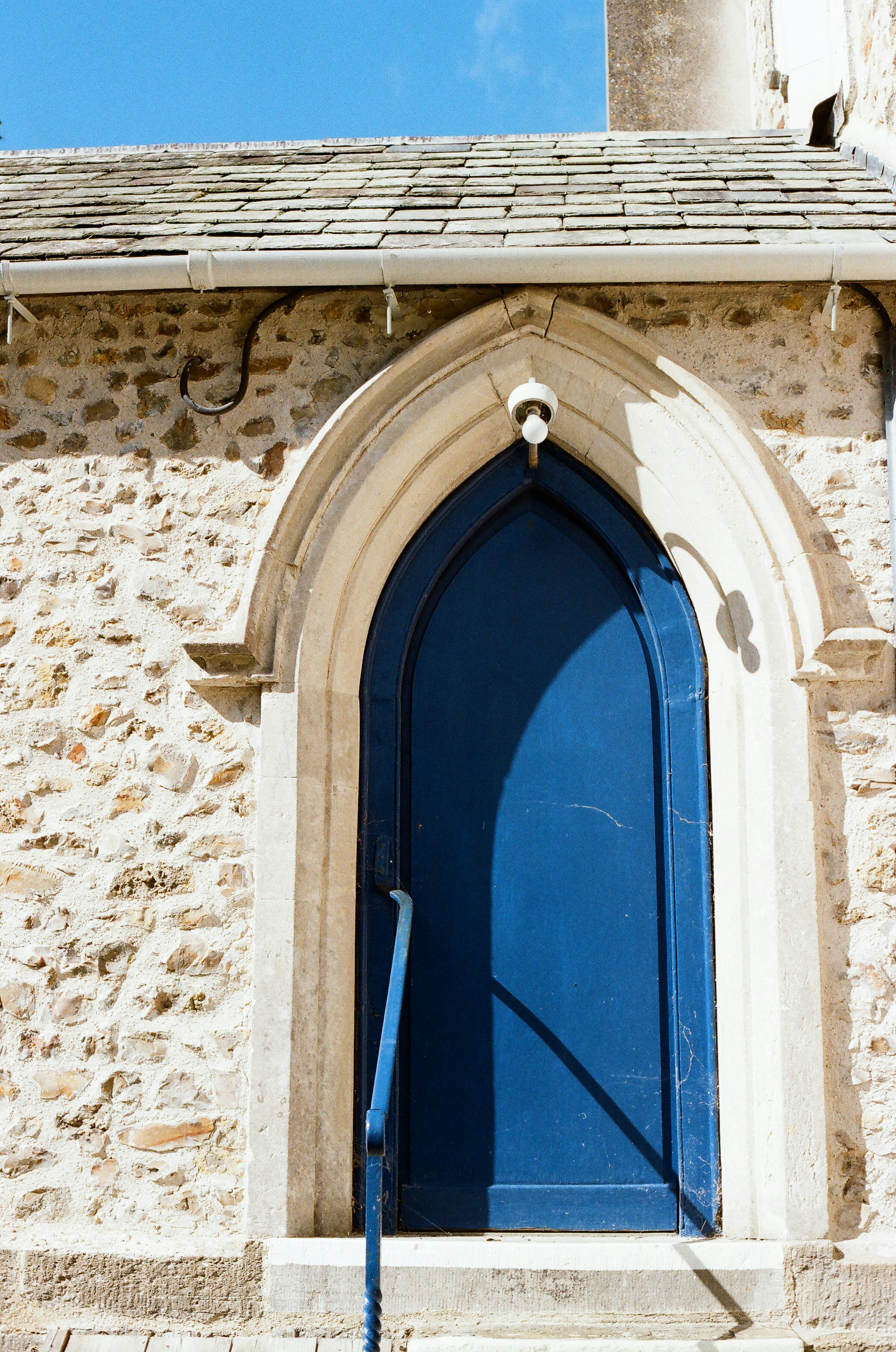 A blue arched door on a stone building. photo – Free Film photography ...