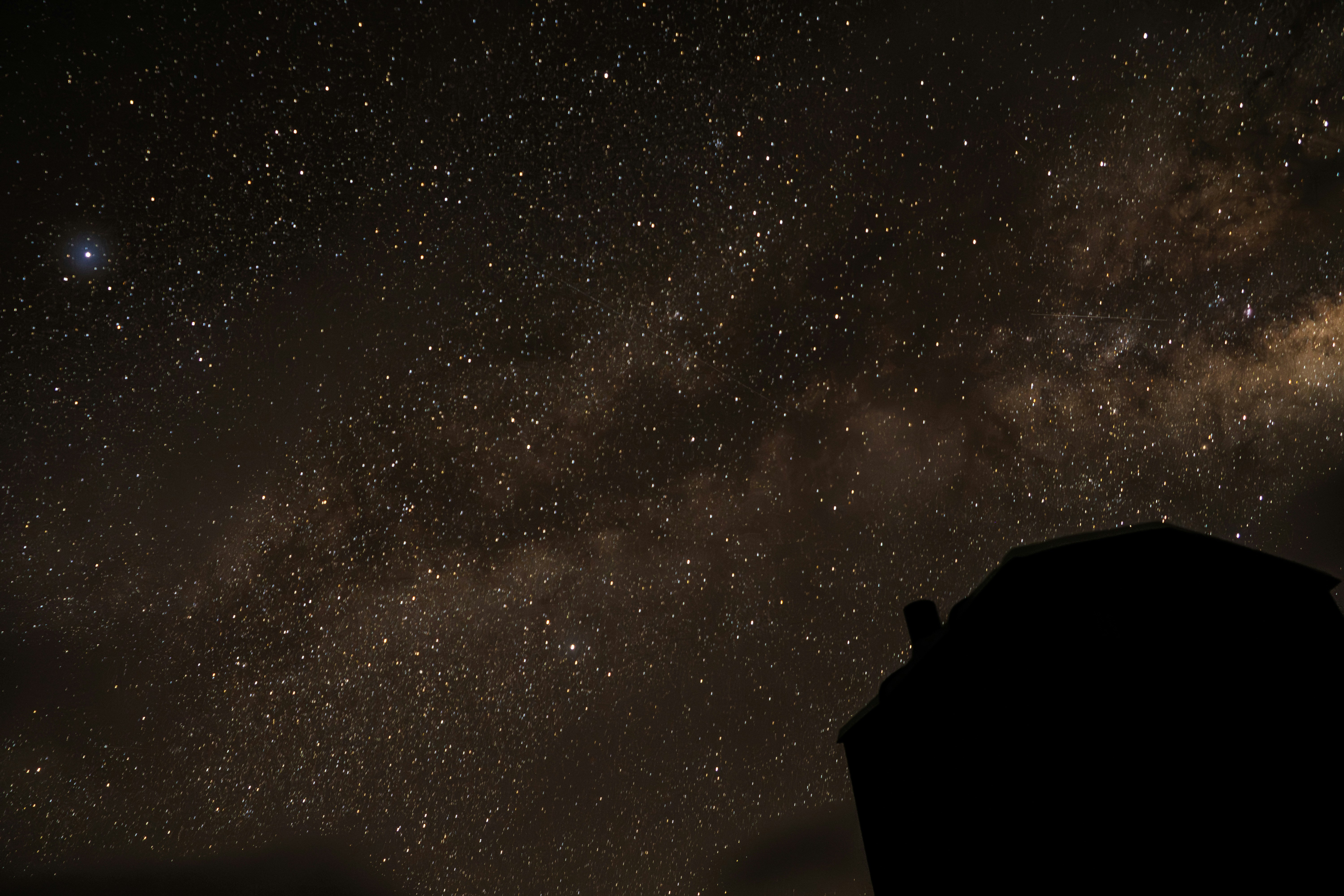 milky way stargazing | Silhouette of an observatory under a starry night sky.