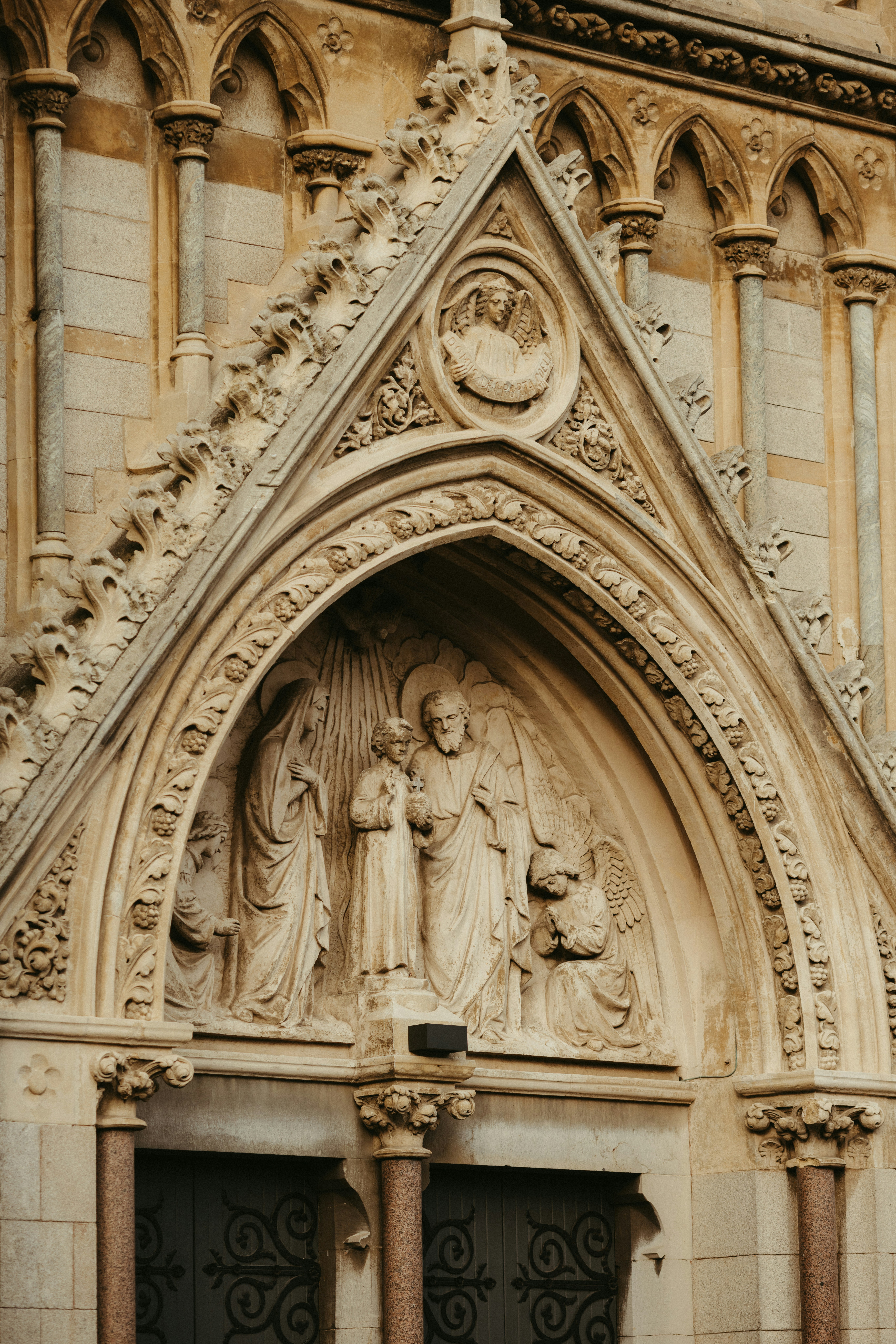 Ornate stone carving above an arched doorway
