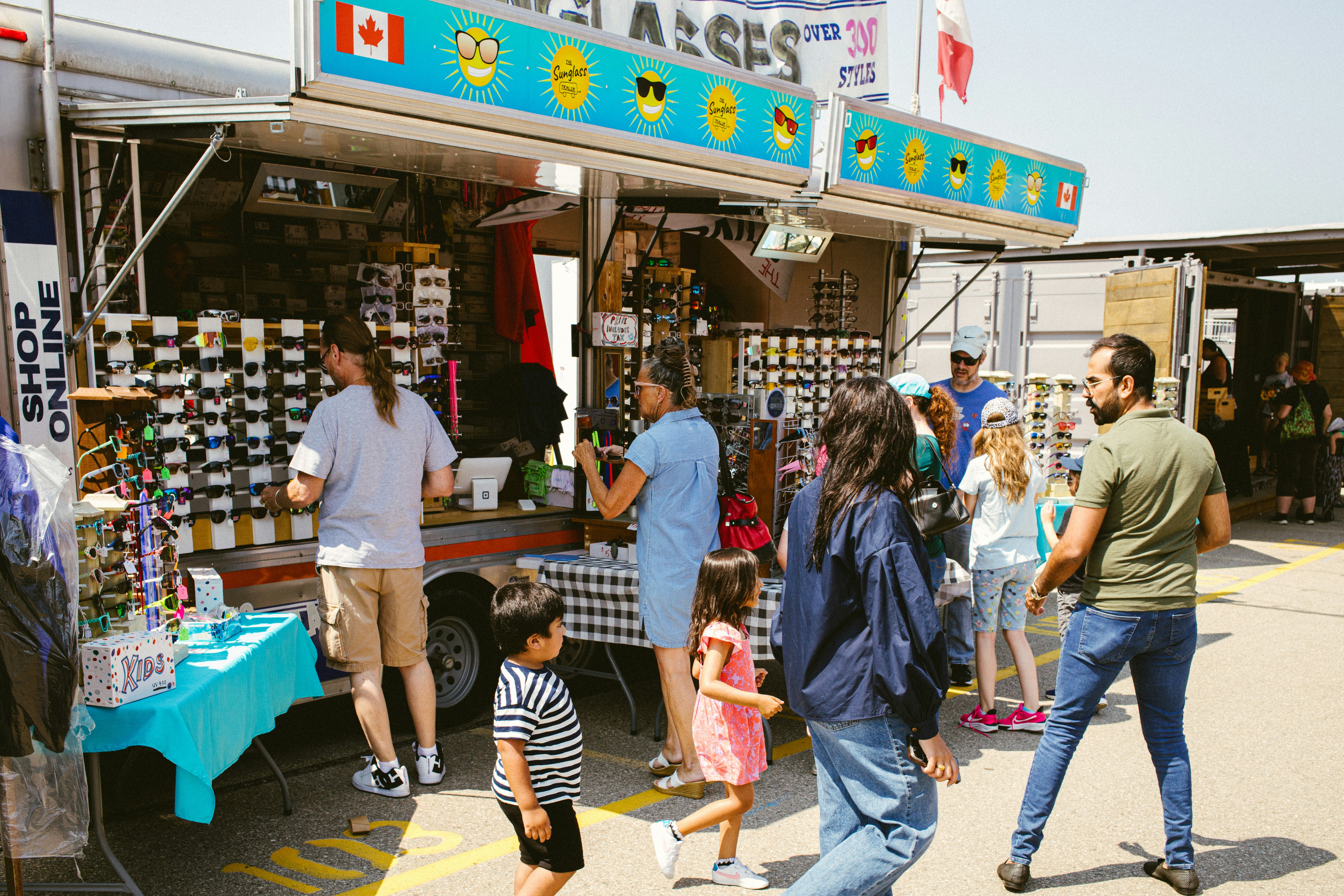 Sunlit Market Stalls: Sunglasses, Snacks and Smiles