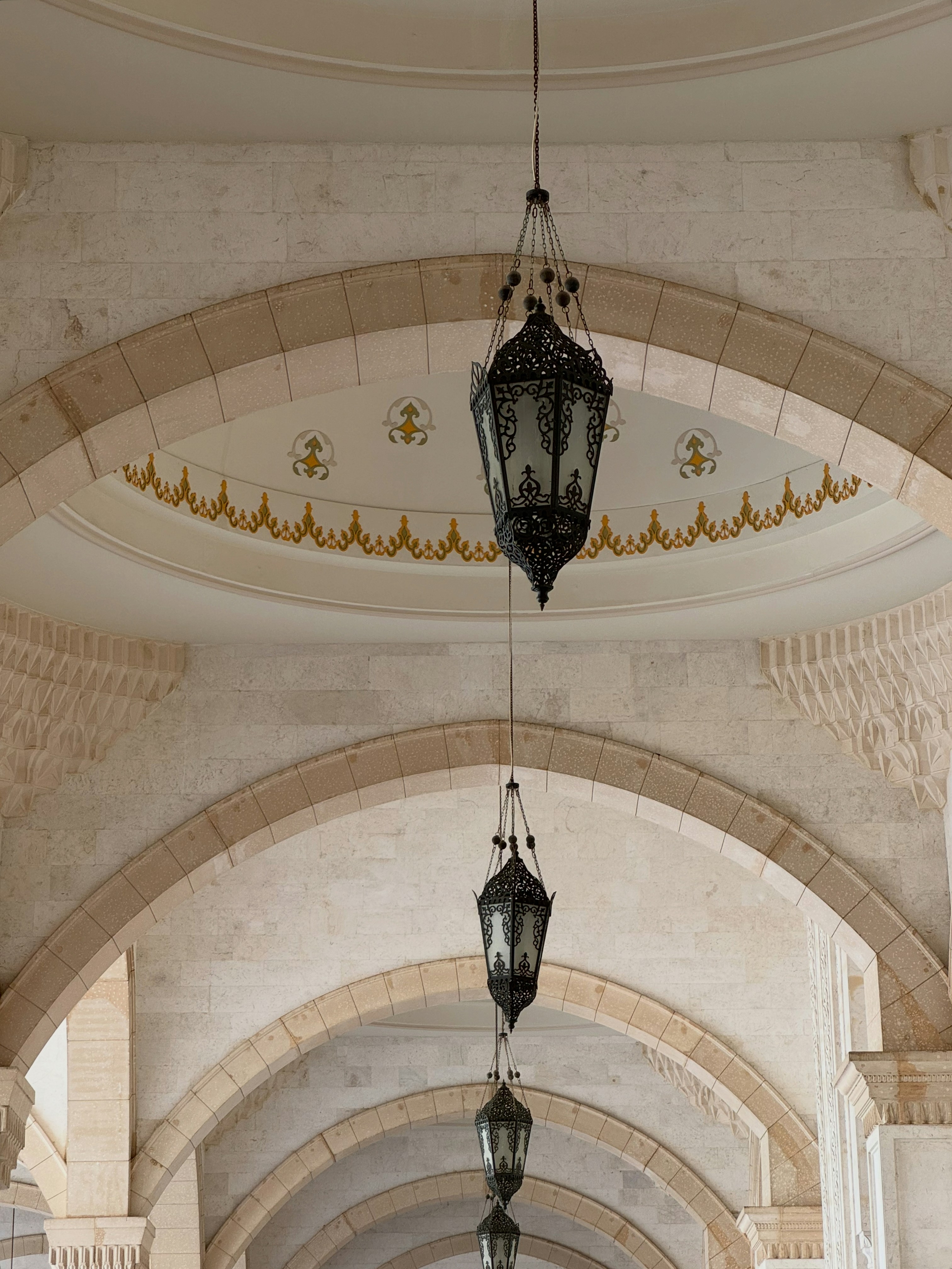 Sheikh zayed Mosque fujairah | Ornate lanterns hang beneath arched walkways.