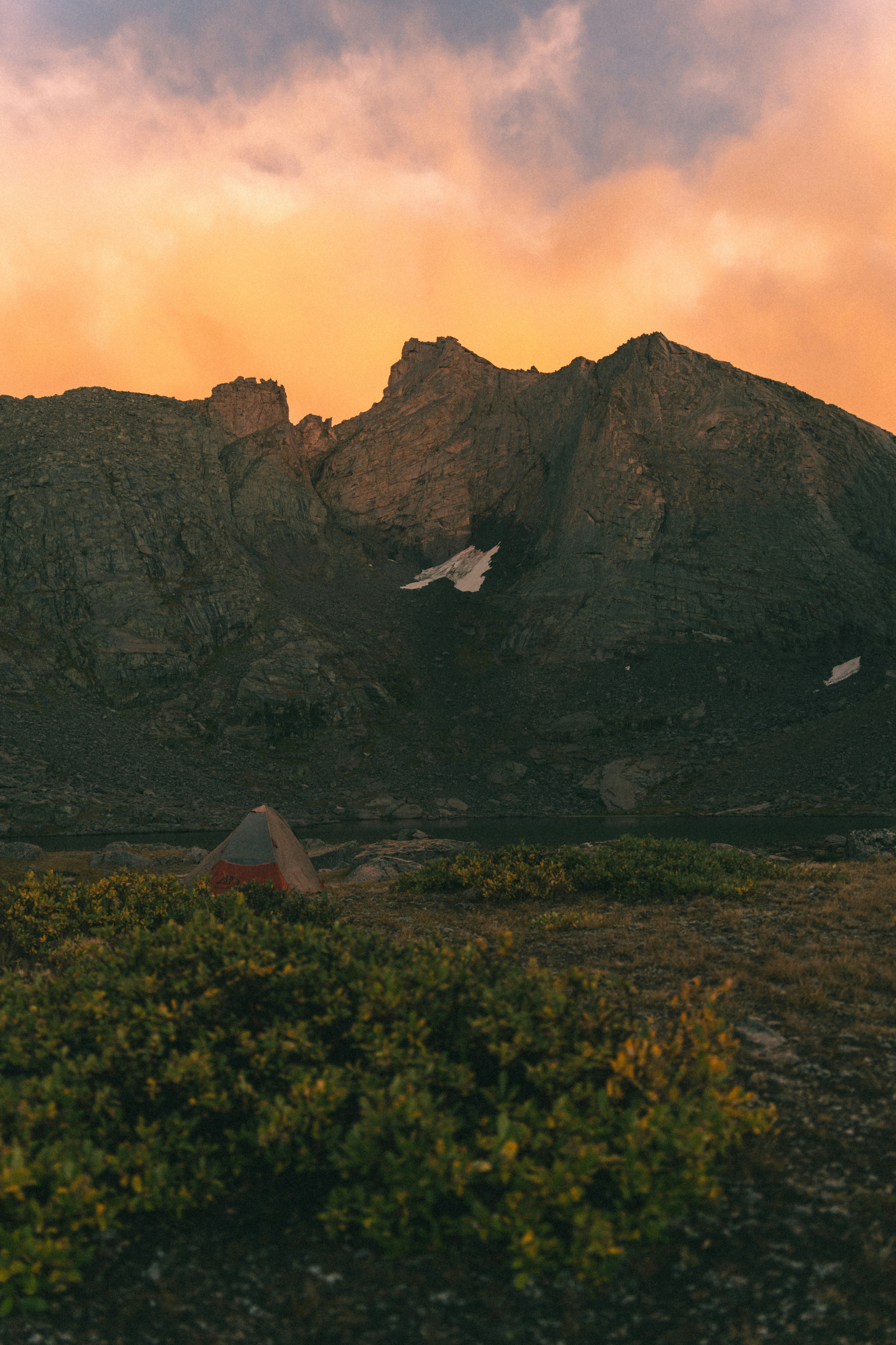 Sunset Ridge and Tent: Ember Light Over a Remote Alpine Camp