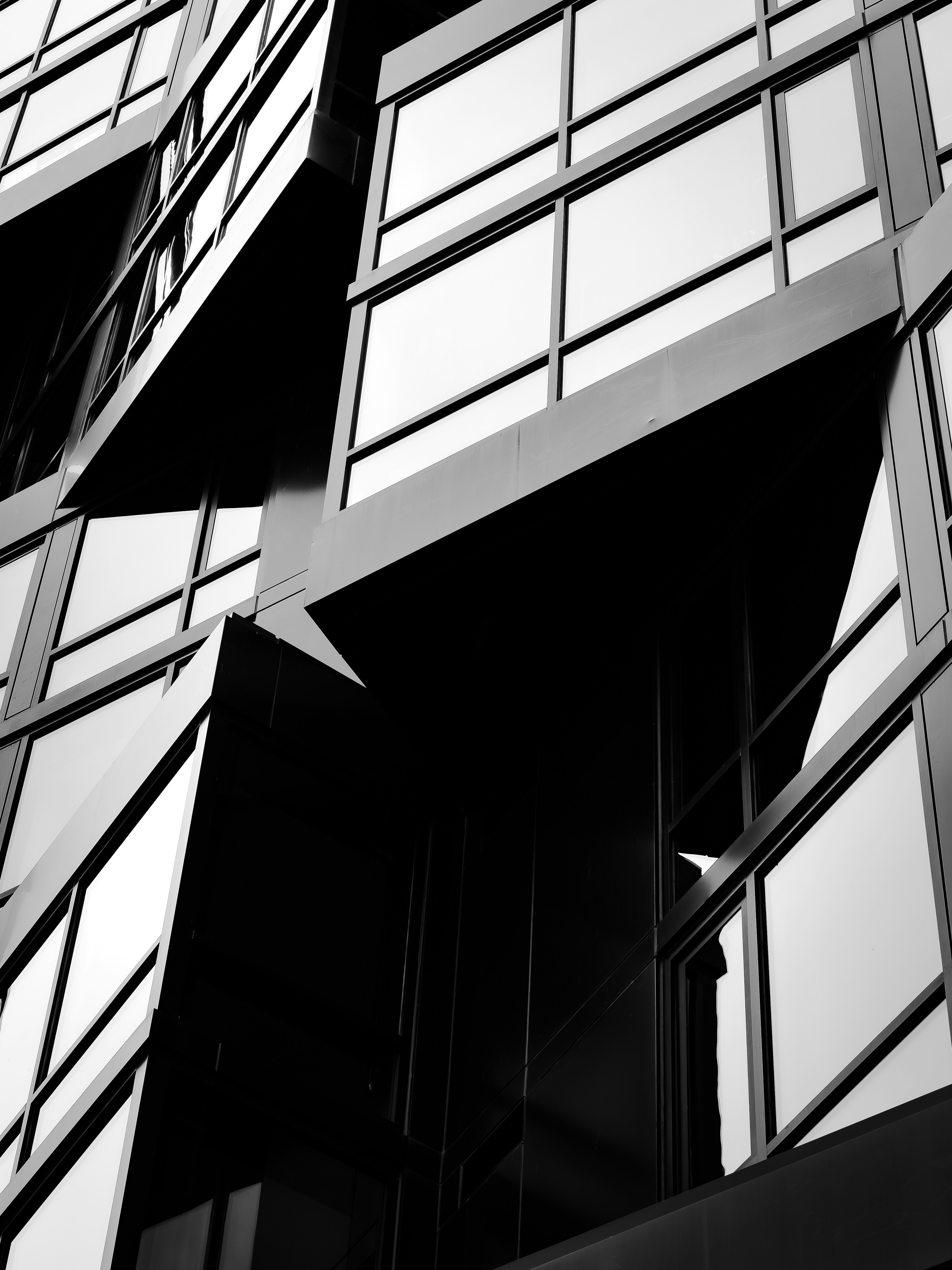 Shapes on a modern building facade | Modern building facade with geometric window patterns.