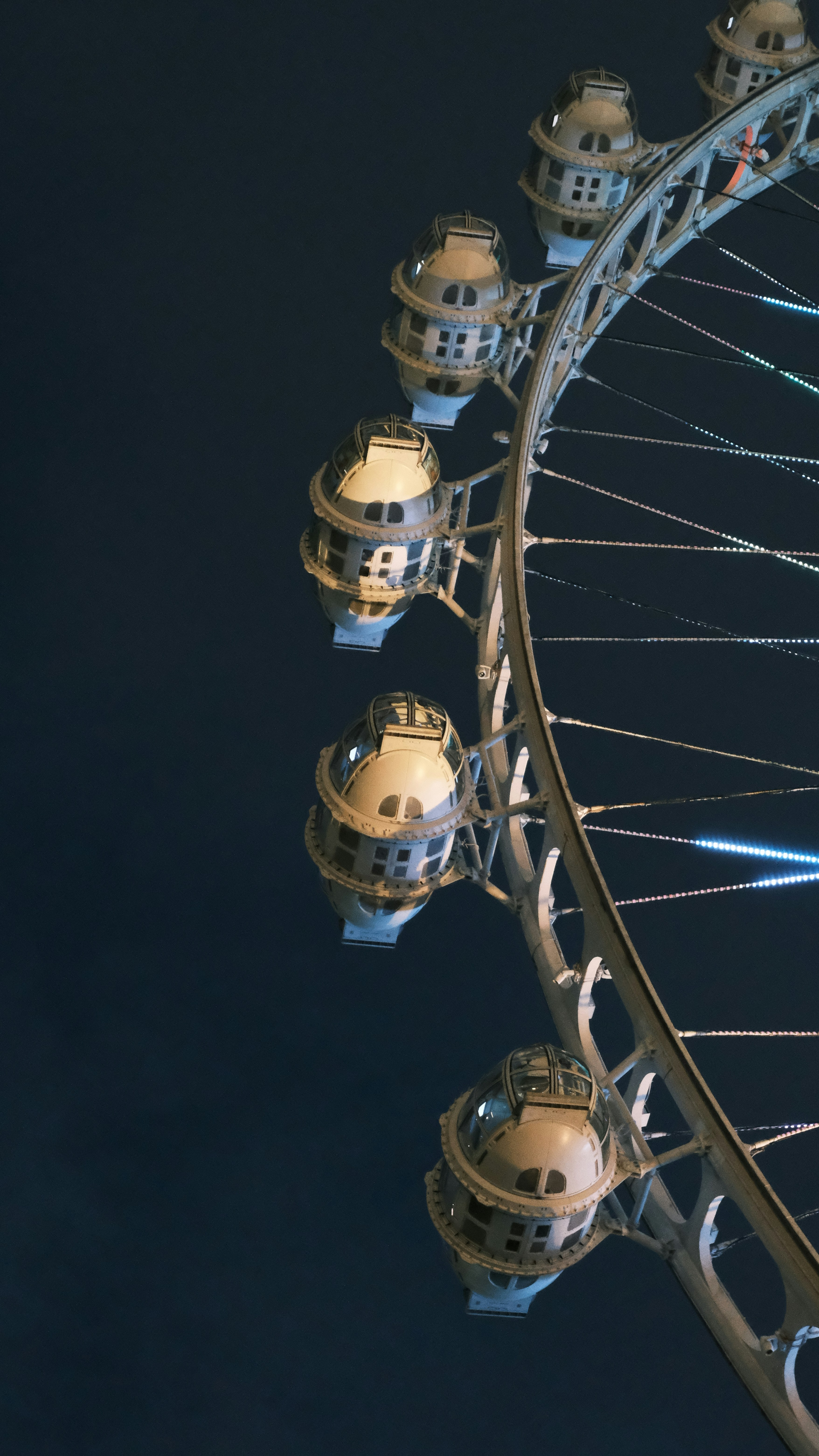 Close-up of a ferris wheel at night