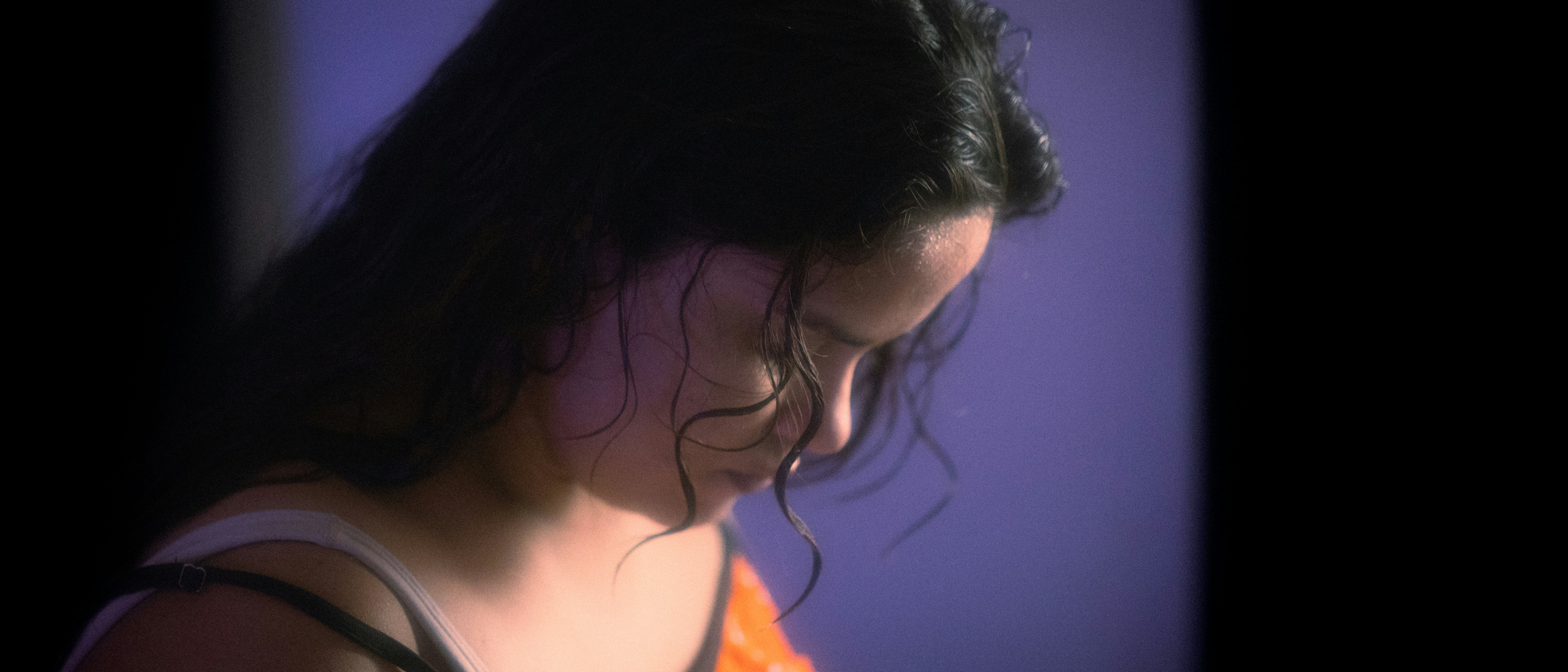 A woman with dark hair looking down