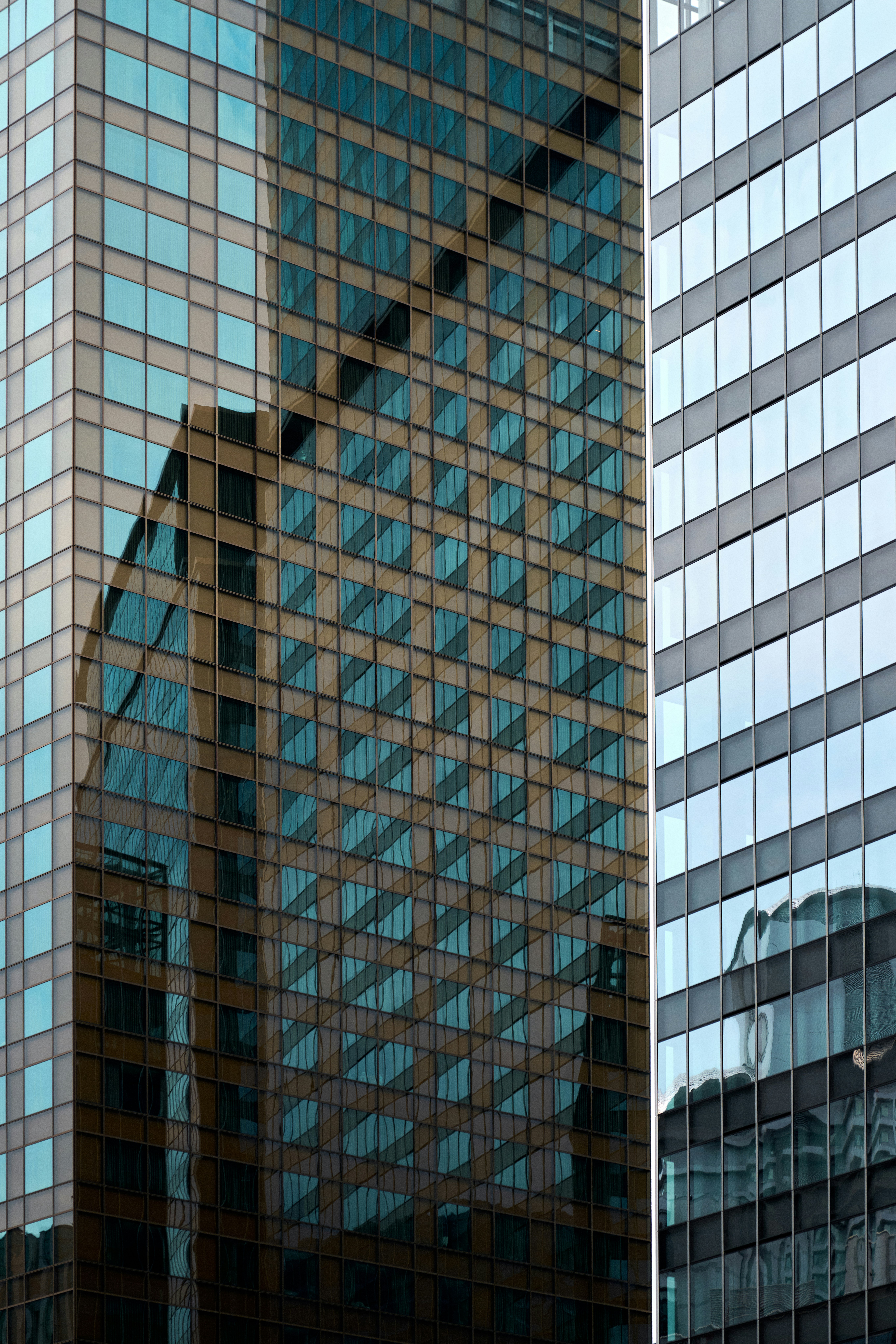 Modern glass buildings reflecting the sky