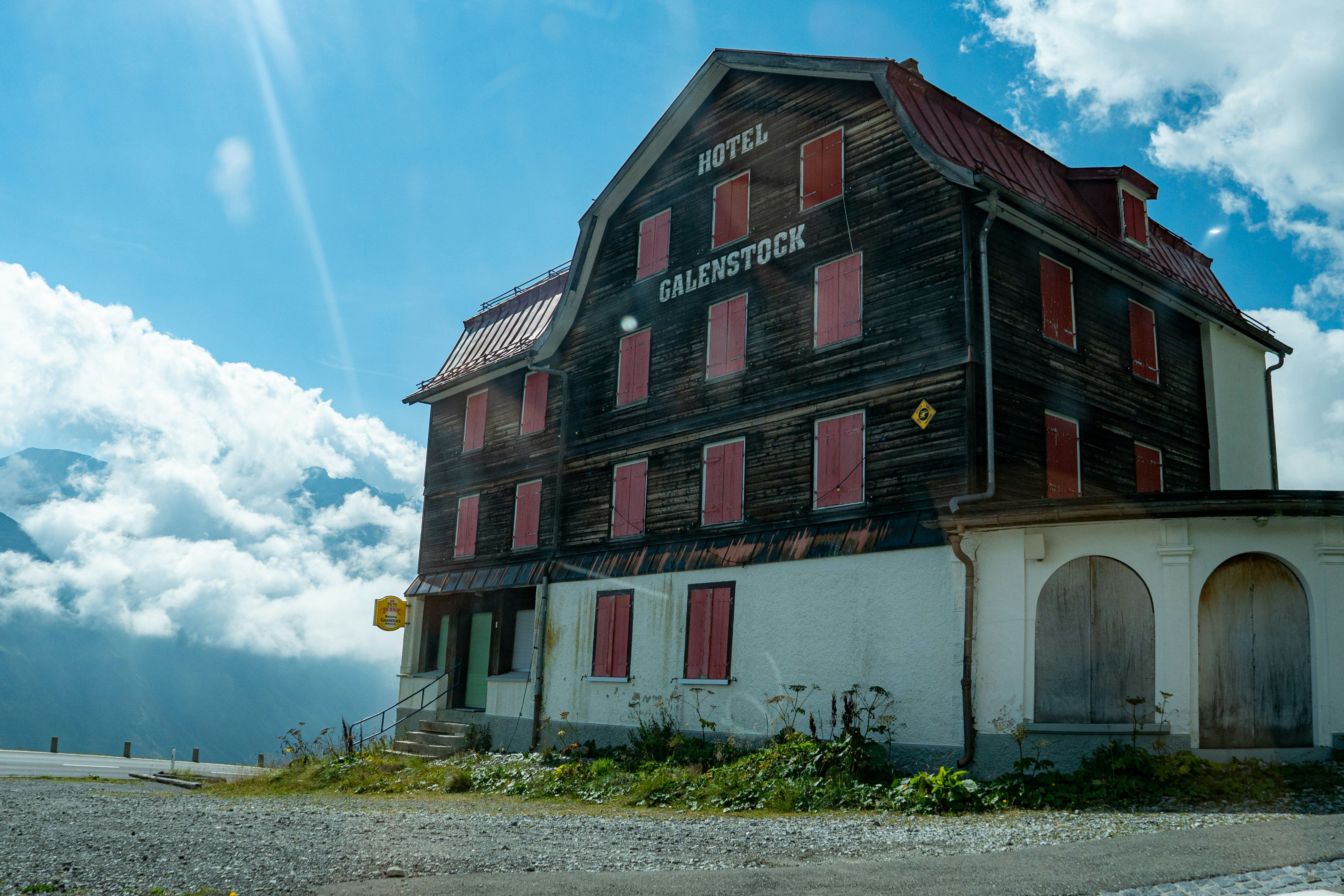 Galenstock on the Cliff: A Weather-Worn Inn Embraced by Sunlit Sky