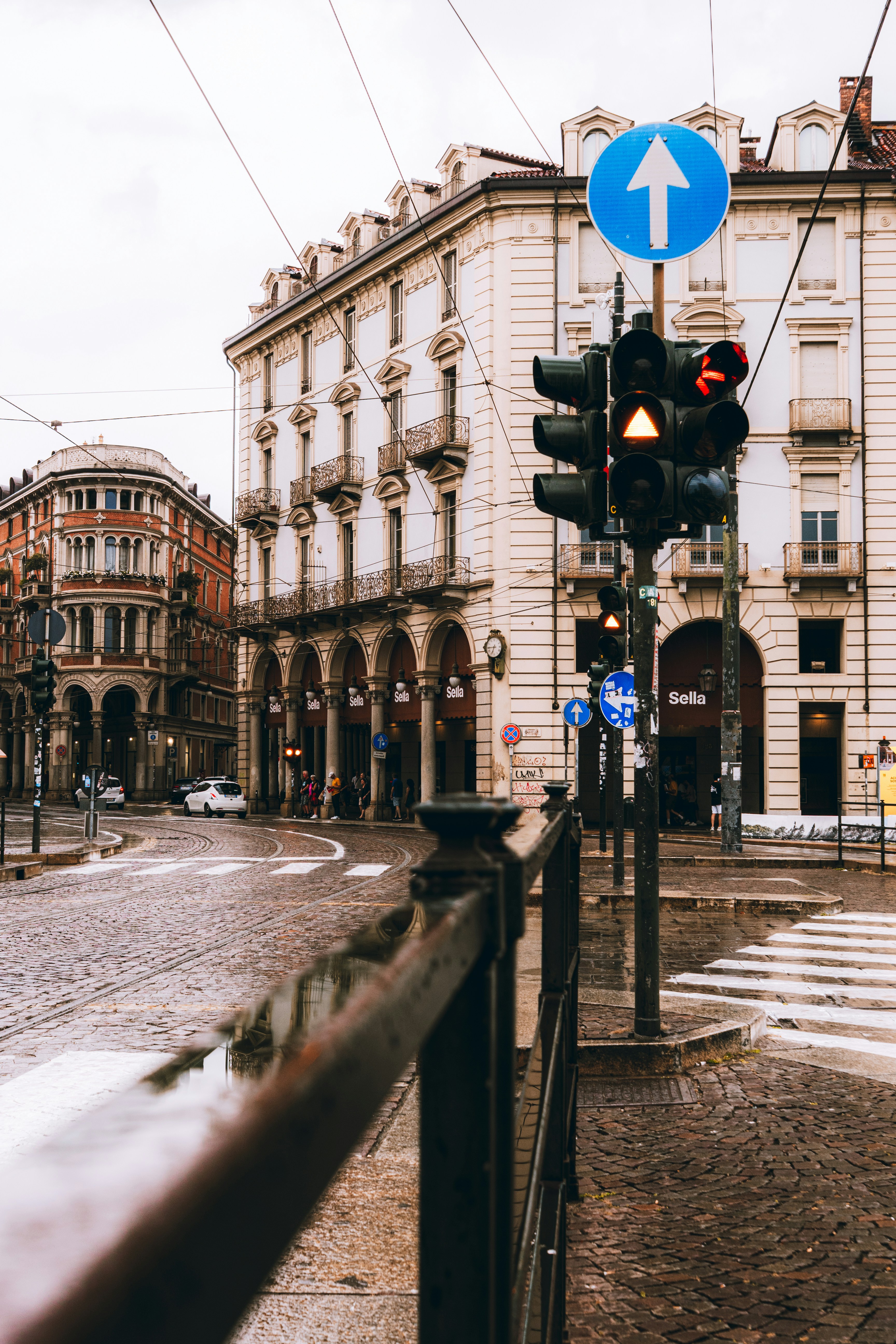 Traffic light and buildings on a wet city street.