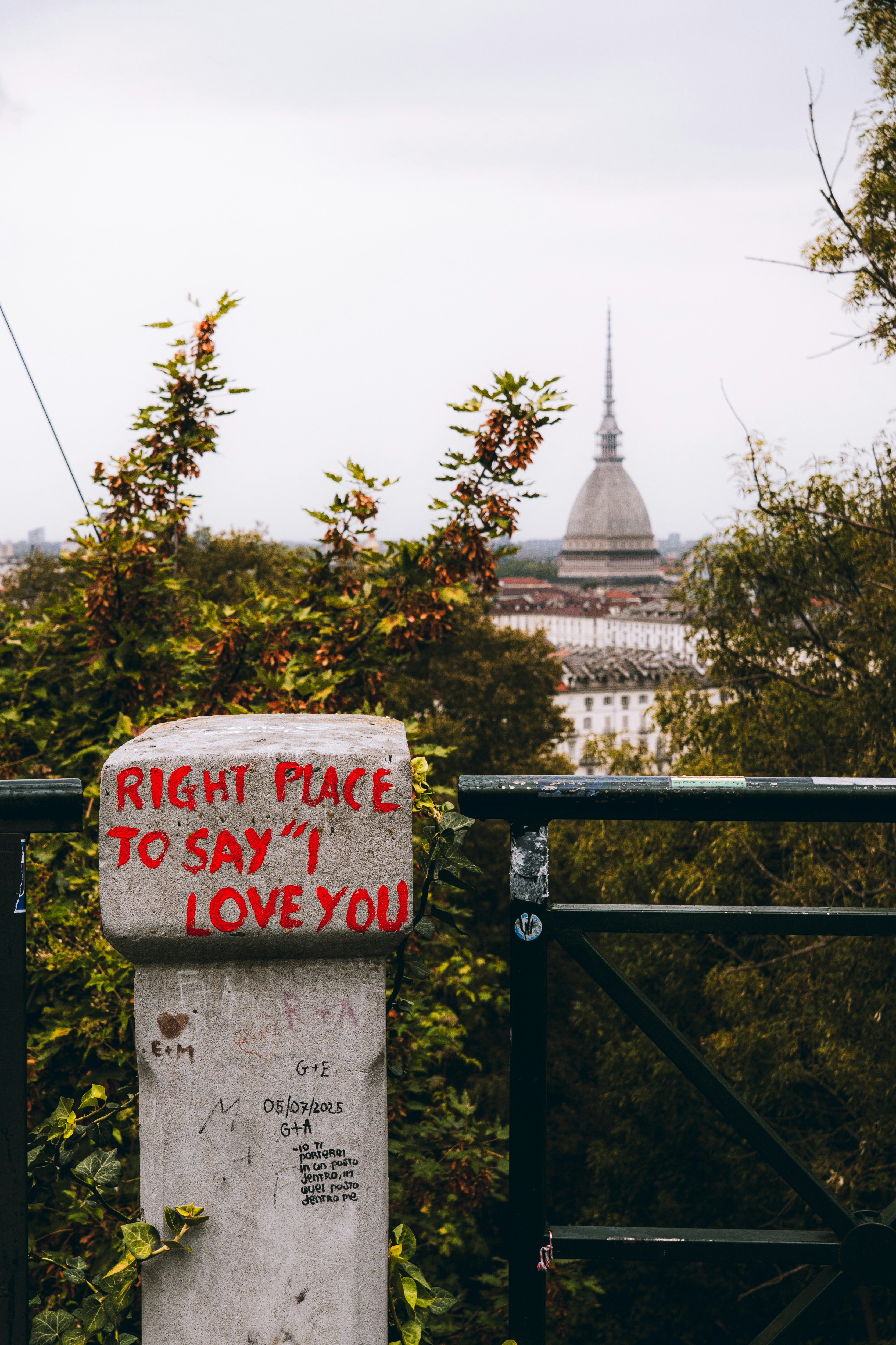 Stone with red text overlooking city skyline