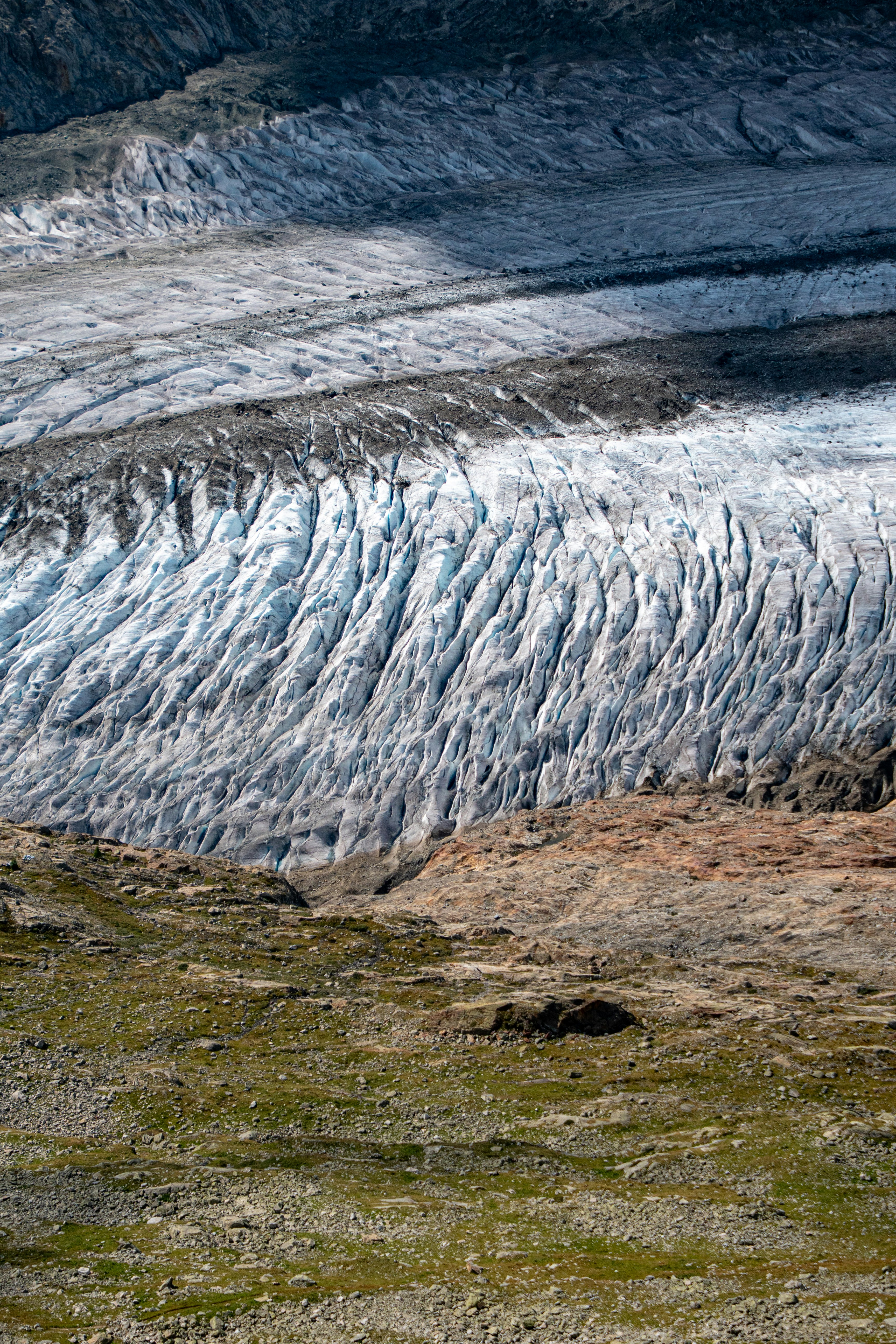 Intricate patterns of a glacier reveal the dynamic interplay of ice and rock, showcasing the beauty of Earth's natural processes.