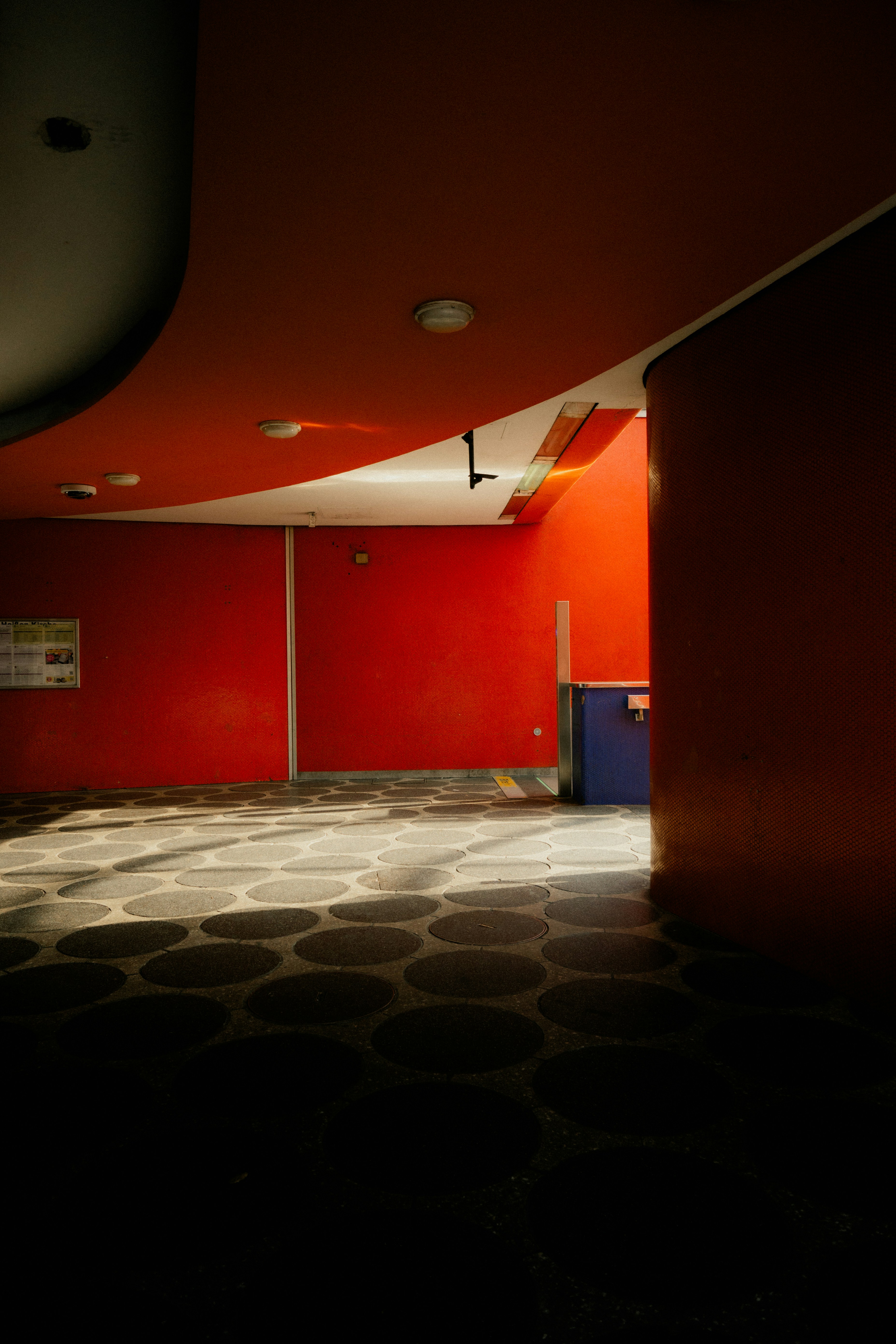 Empty room with red walls and patterned floor.