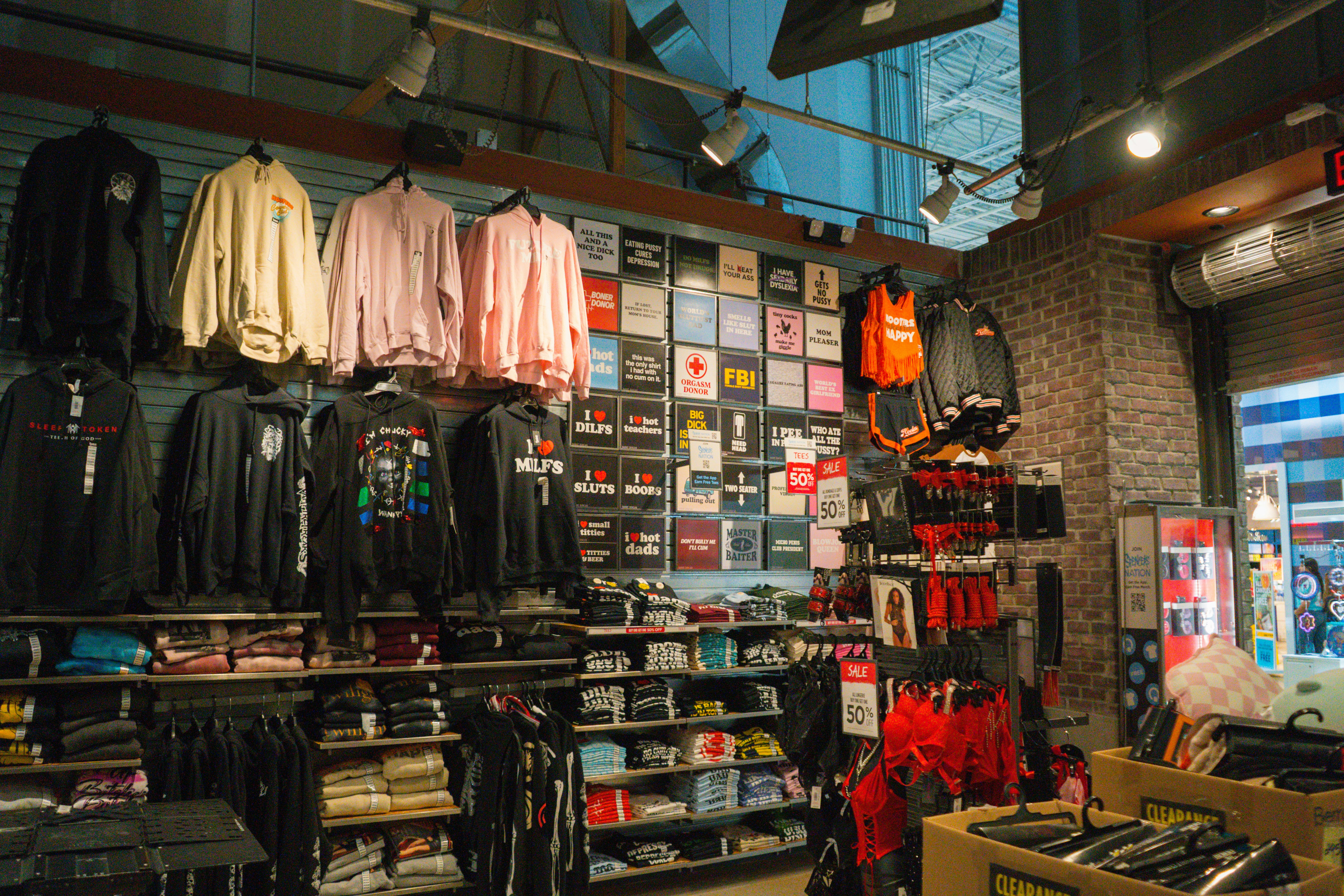 Clothing store interior with shirts and merchandise displayed. photo ...