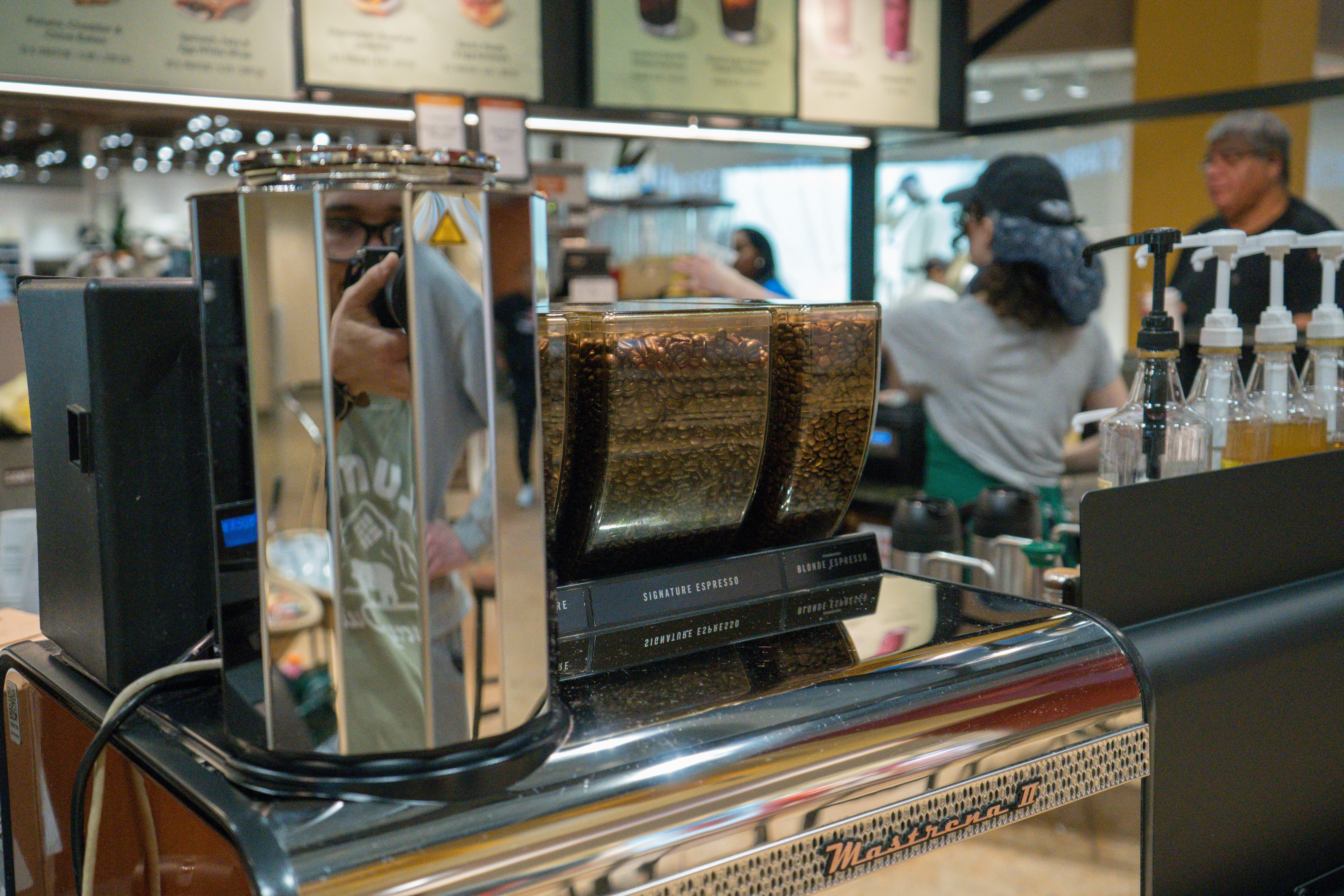 Gloss and Grind: A Busy Café Counter's Chrome Focus