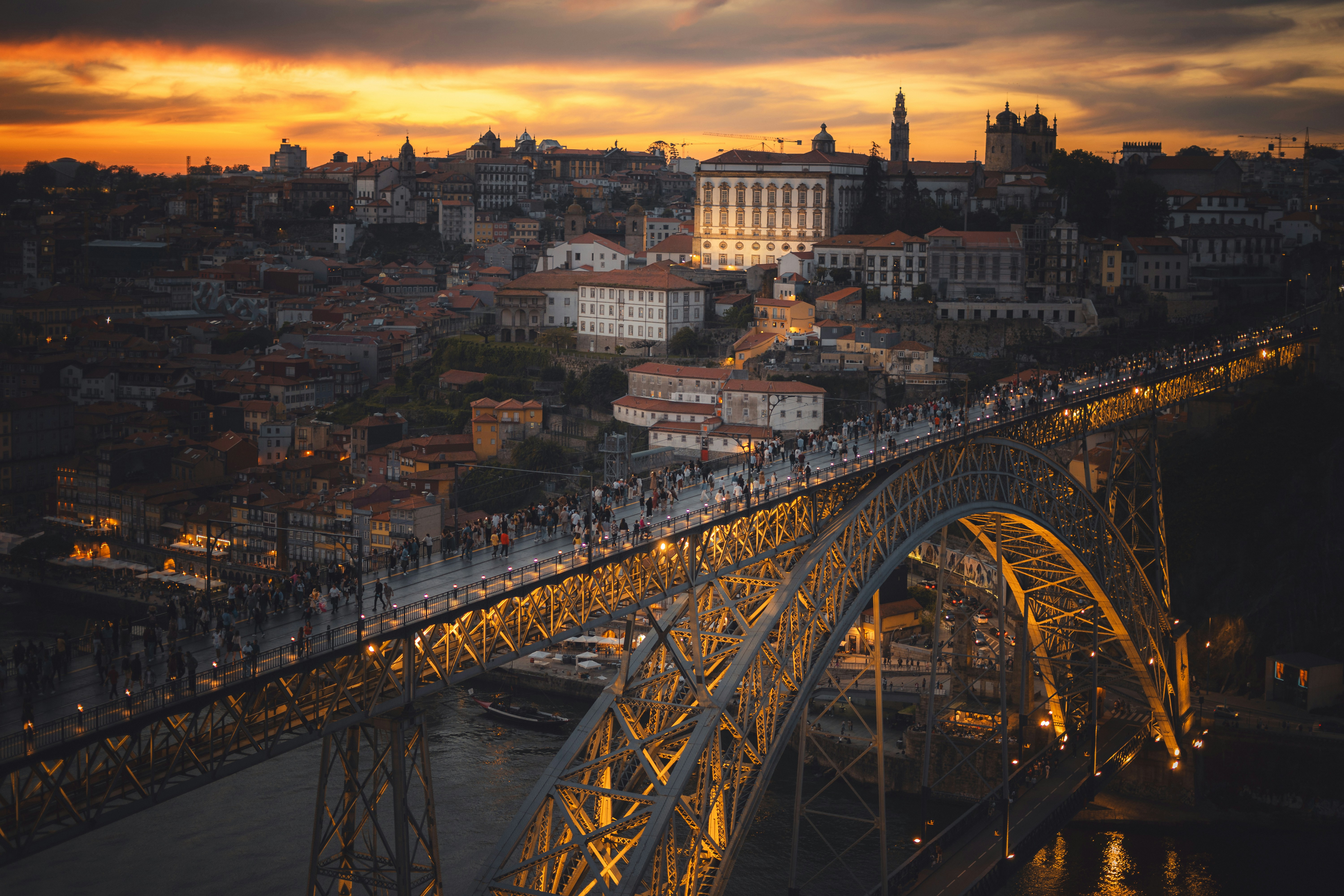 Golden Hour Over the River: A City Looms Beneath a Luminous Arch