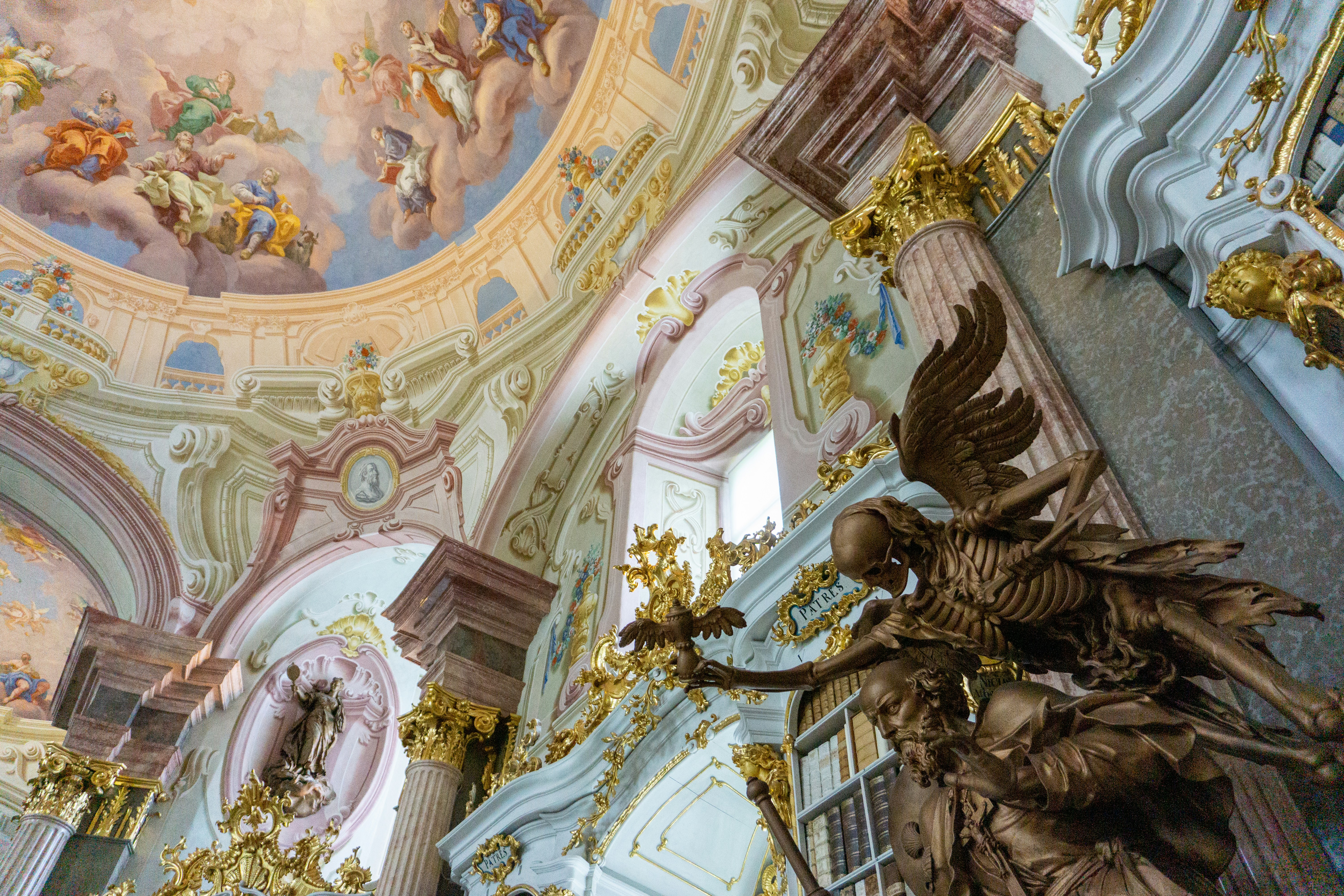 Ornate baroque interior with gilded statues and frescoes.
