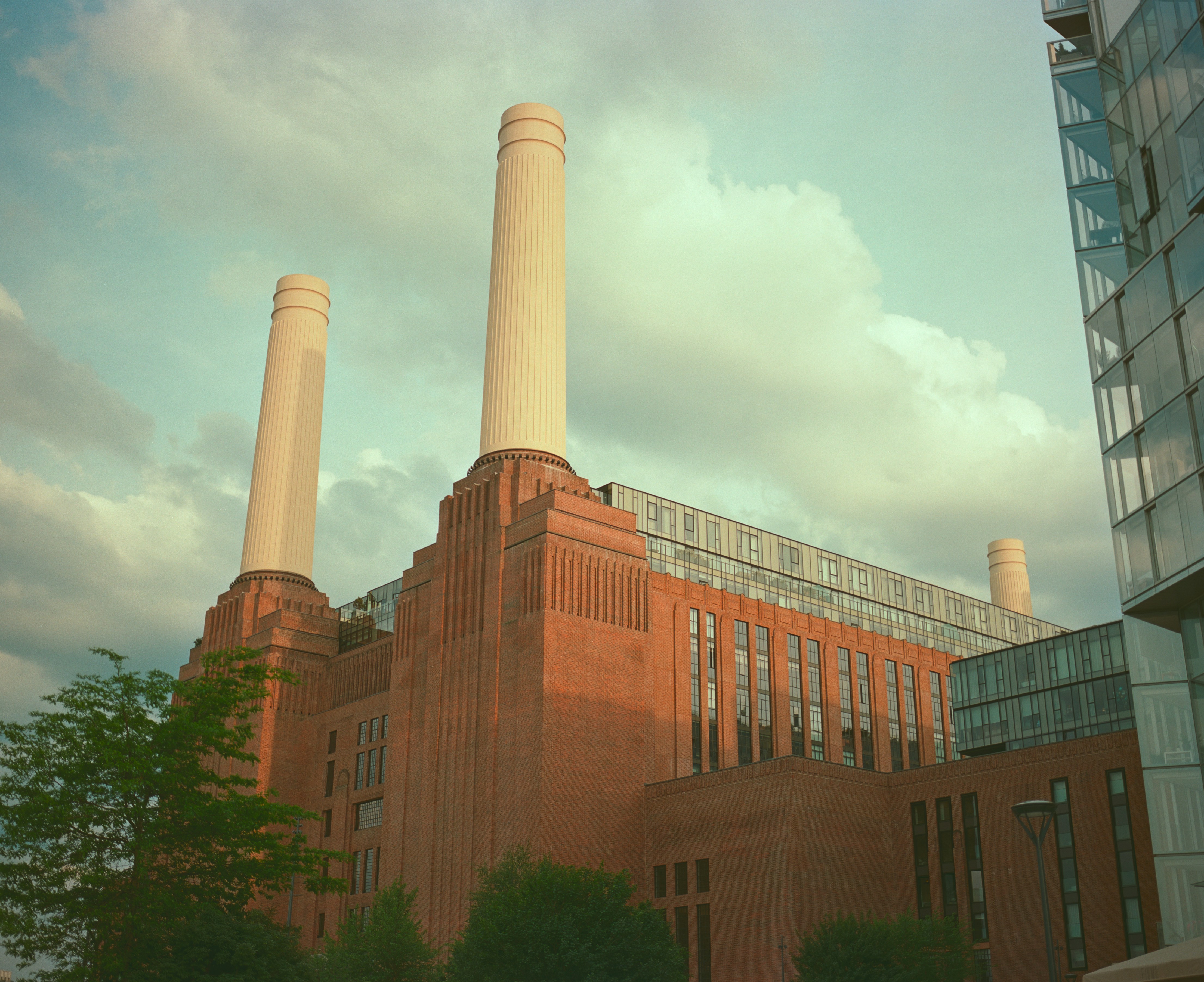 Battersea Power Station, London, UK; evening glow, warm tones, iconic architecture.