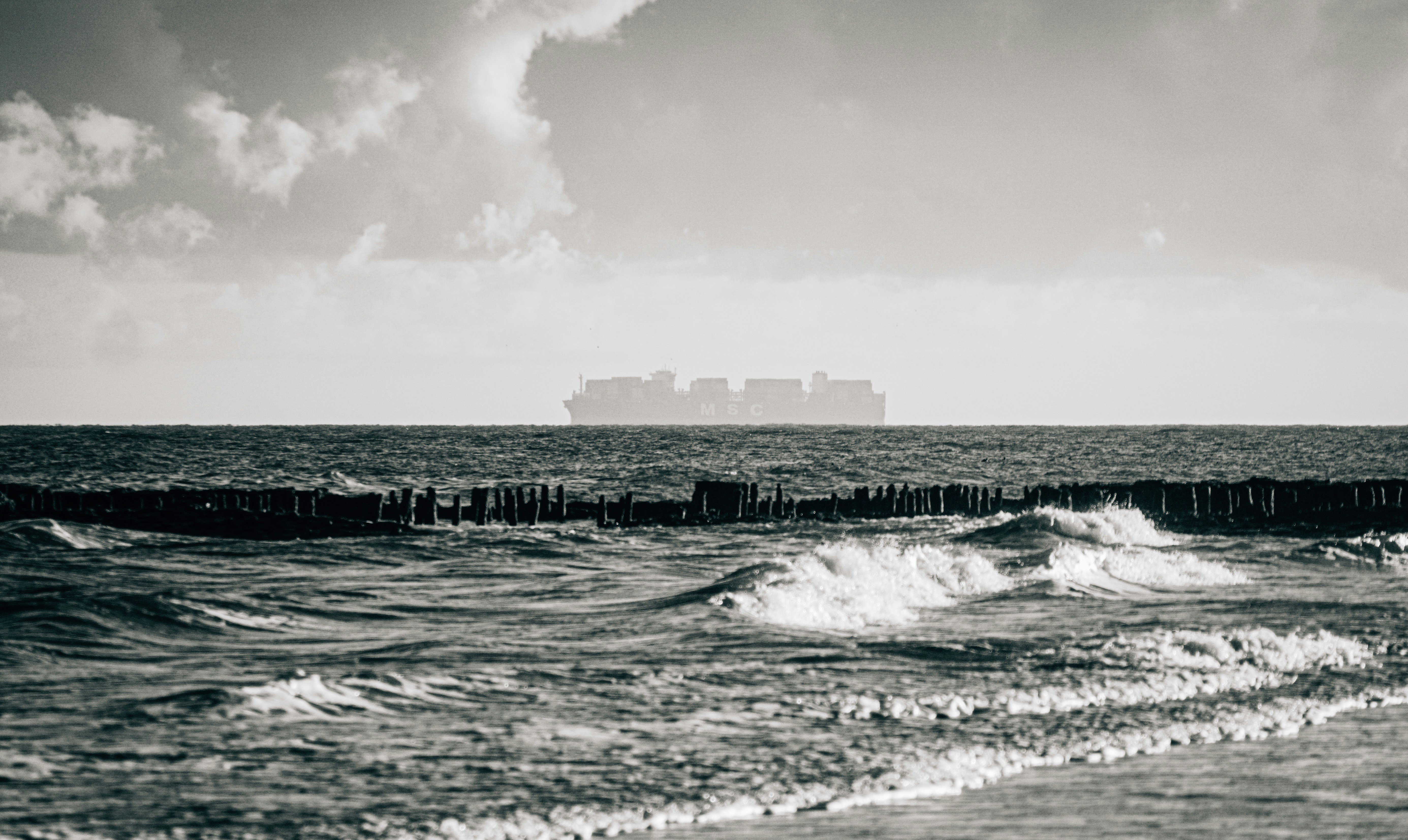Cargo ship on the horizon over choppy waves photo – Free Sea Image on ...