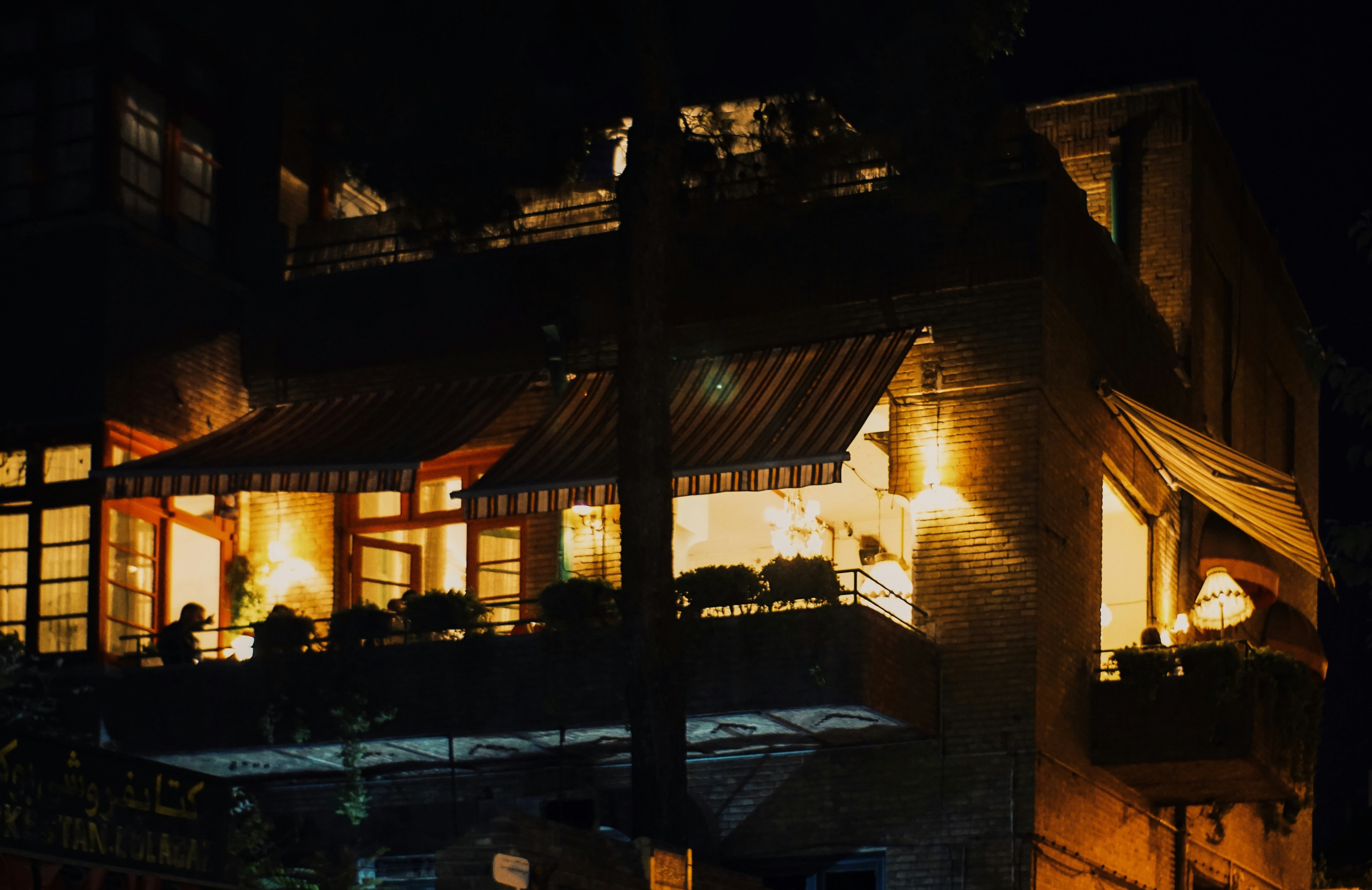 A pocket of warmth in the cool night. | Building with illuminated windows at night