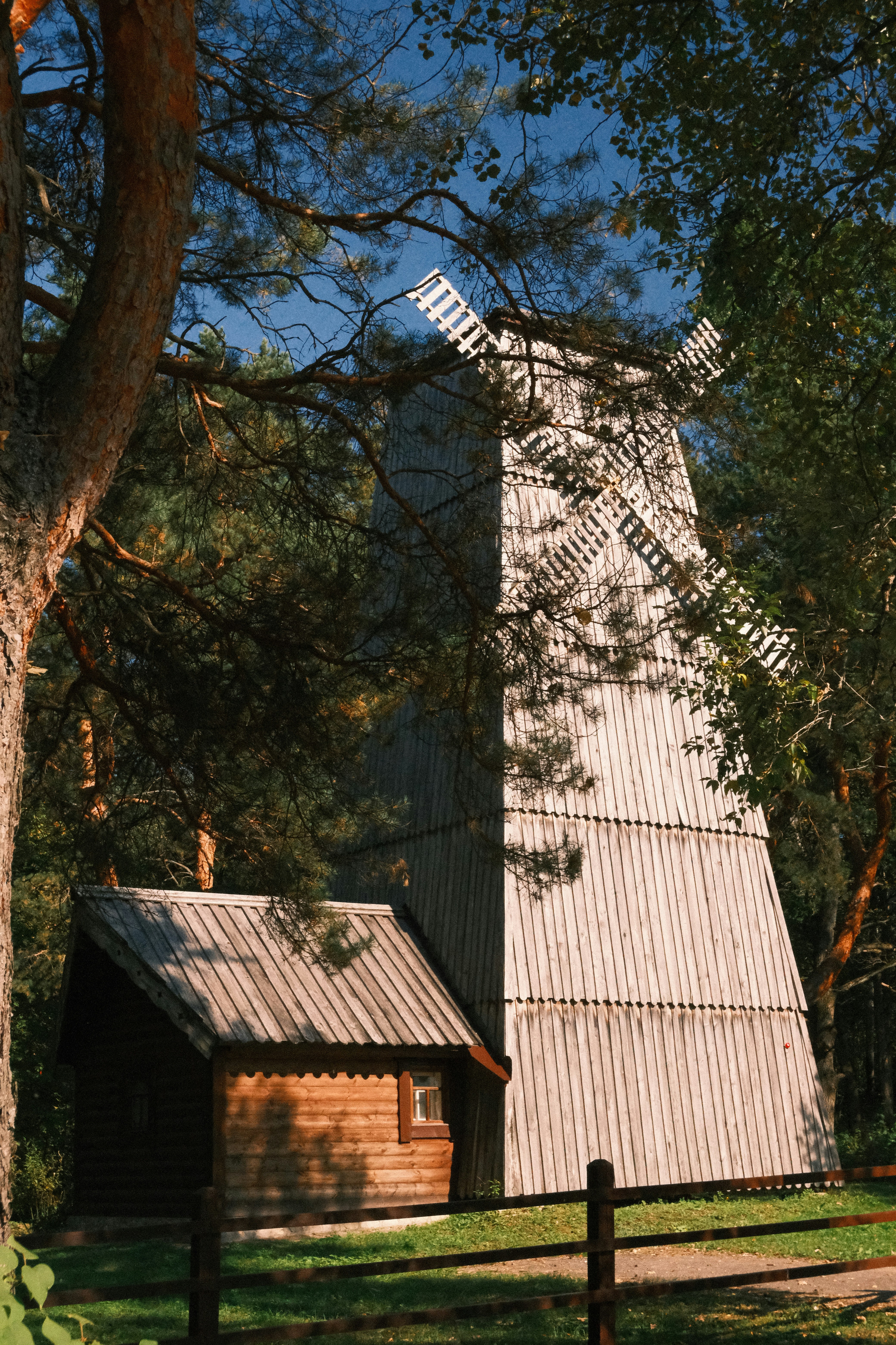 Whispers of the Past: A Rustic Windmill and Cabin