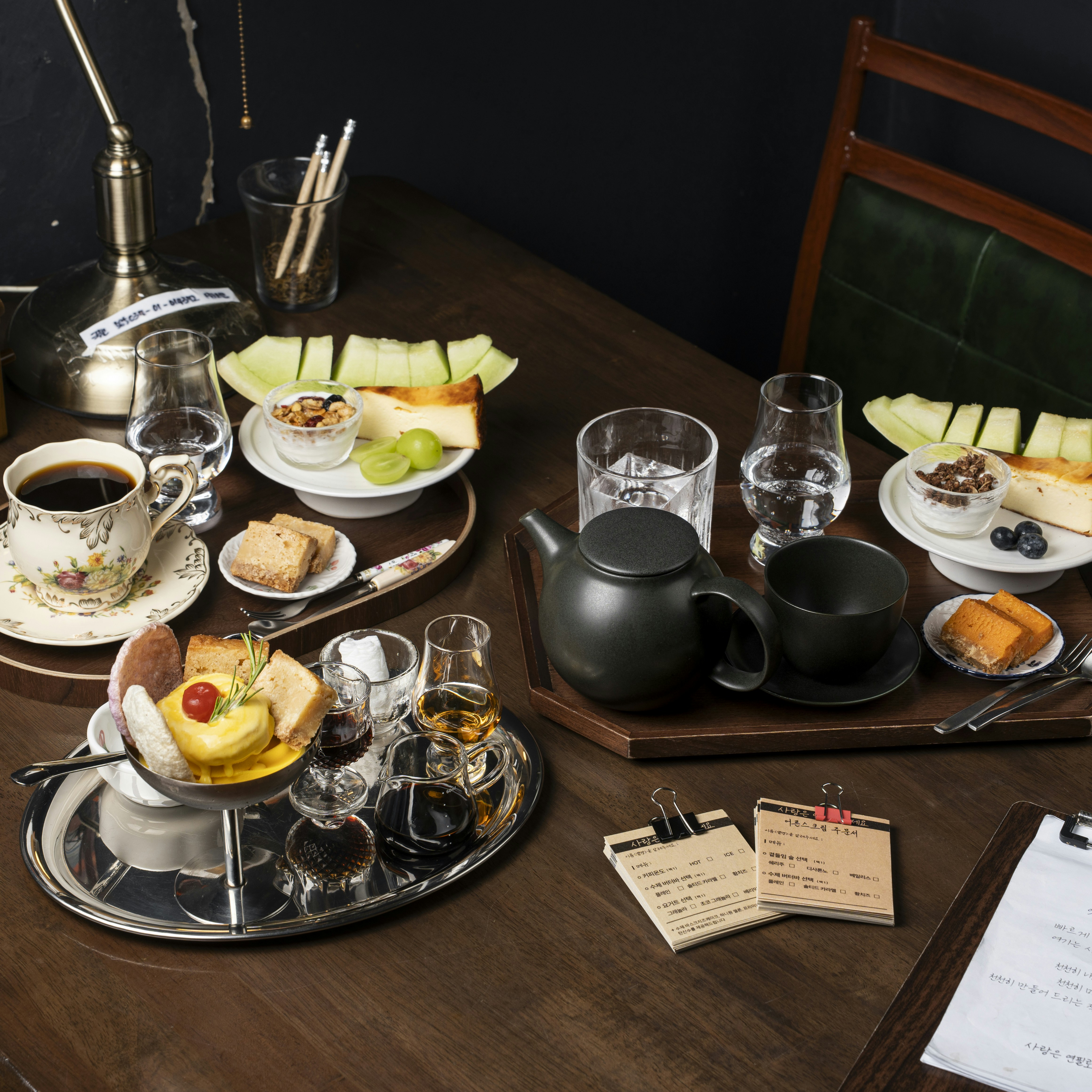 An inviting spread of various desserts, fruits, and beverages arranged elegantly on a rustic wooden table, showcasing a blend of textures and colors.