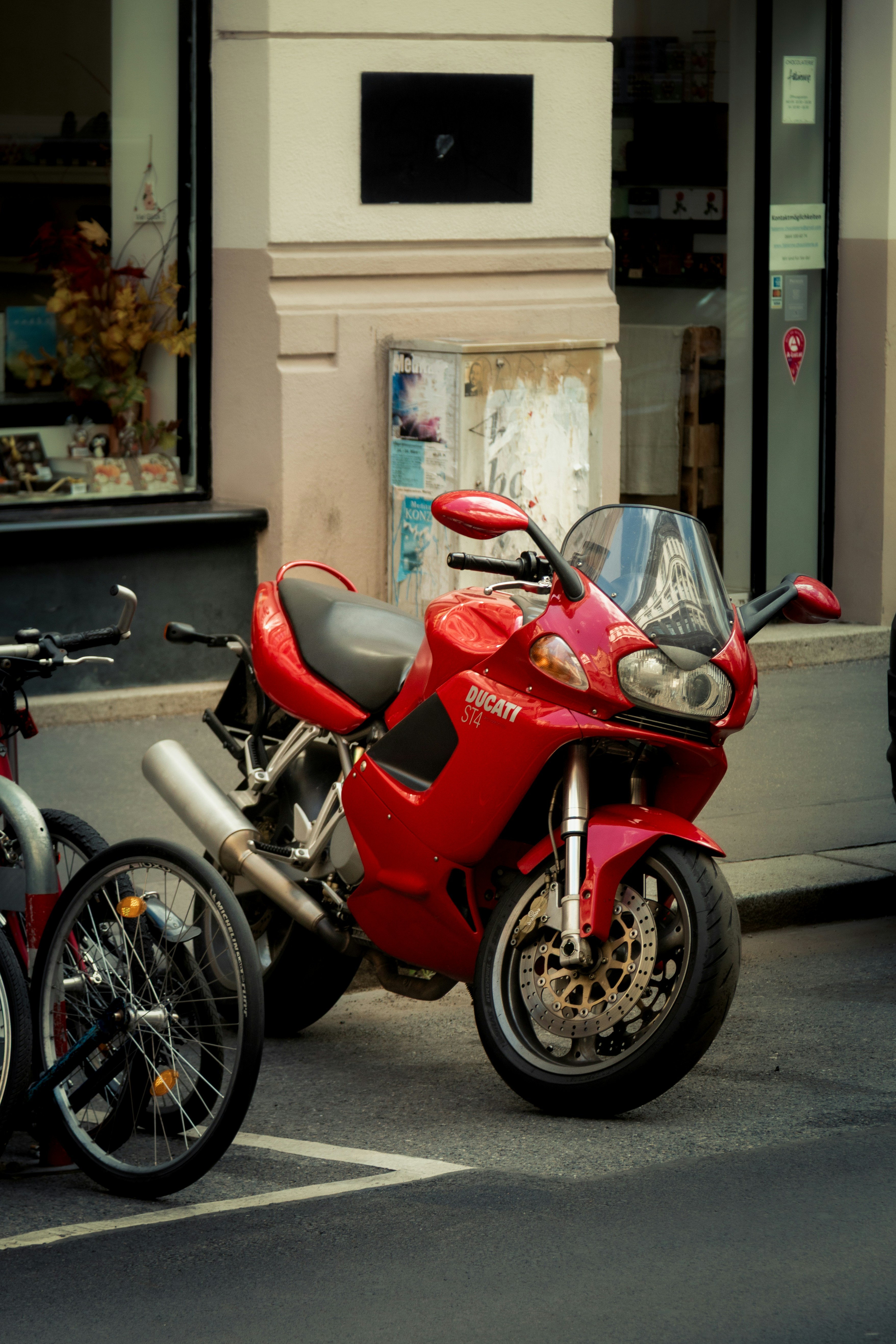 A red motorcycle parked on a city street.
